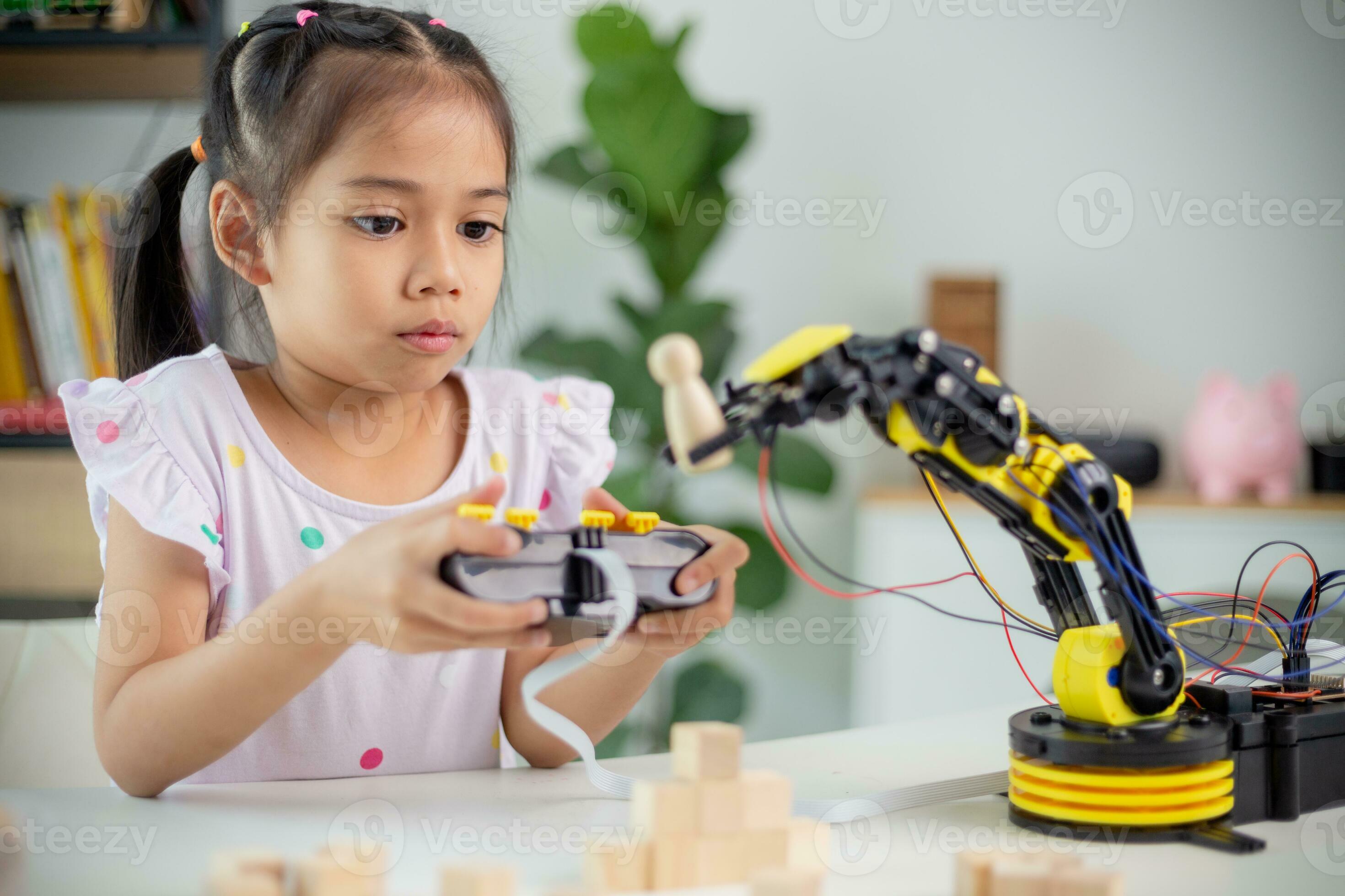 STEM education concept. Asian students learn at home by coding robot ...