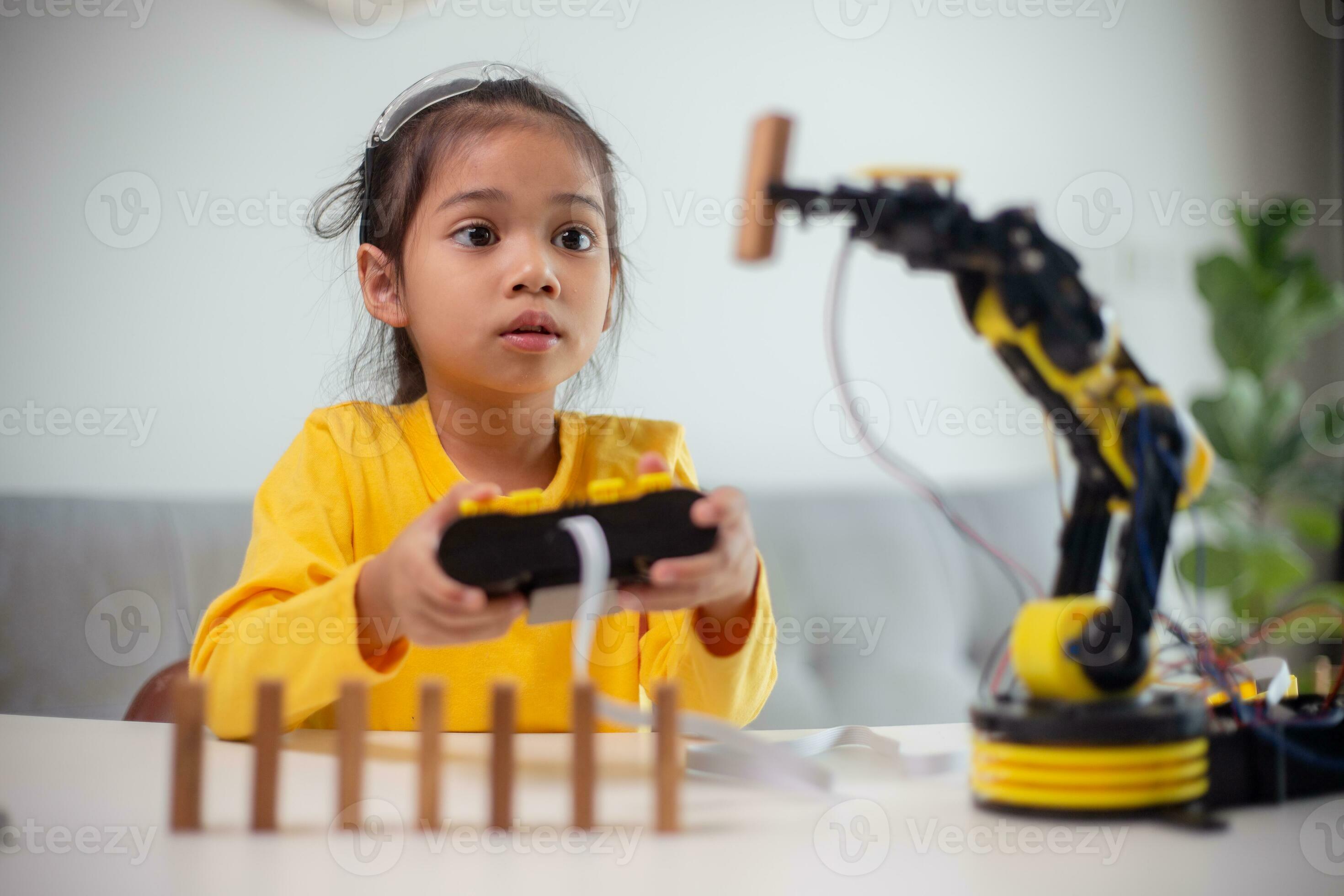 STEM education concept. Asian students learn at home by coding robot ...