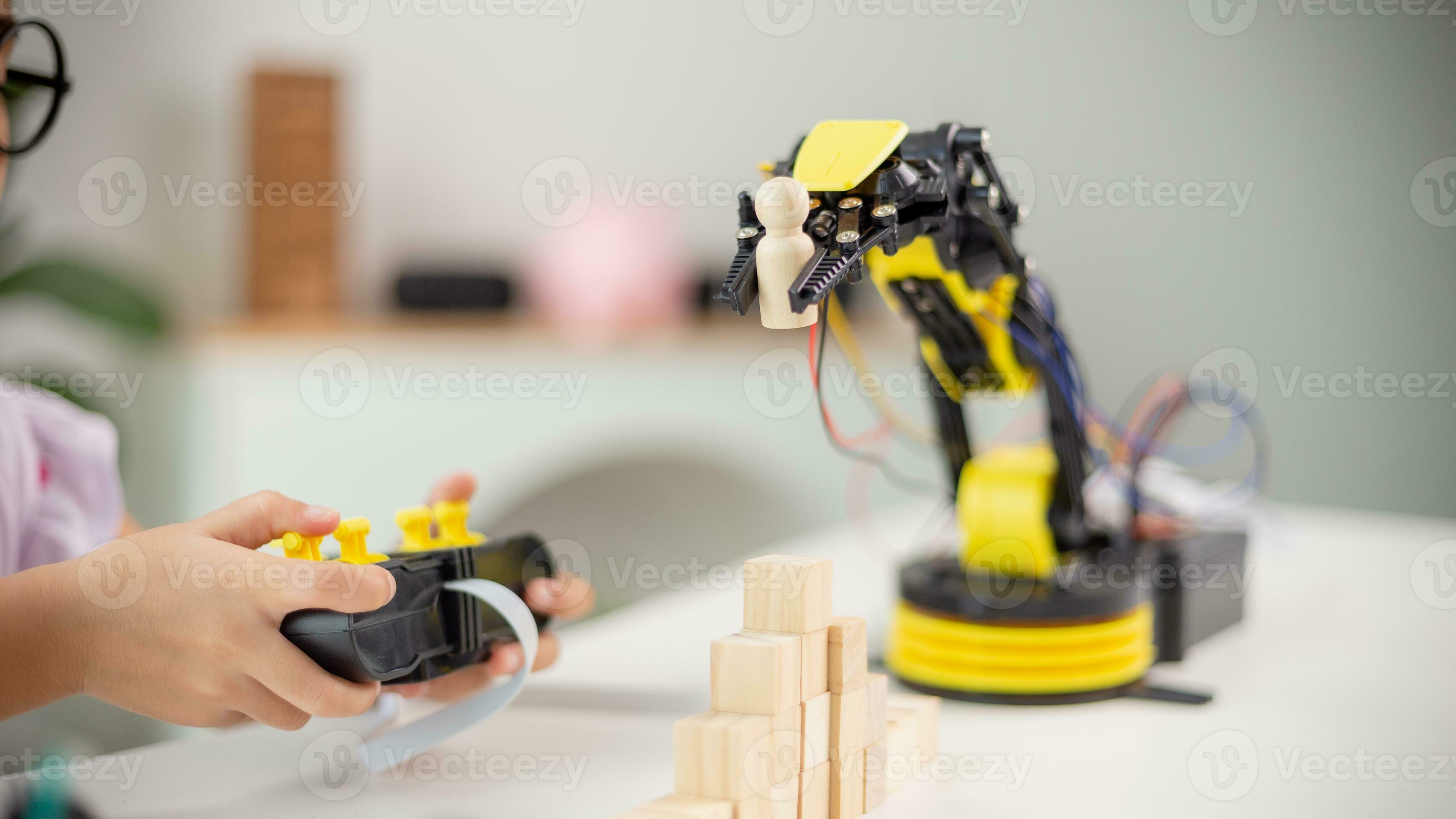 STEM education concept. Asian students learn at home by coding robot ...