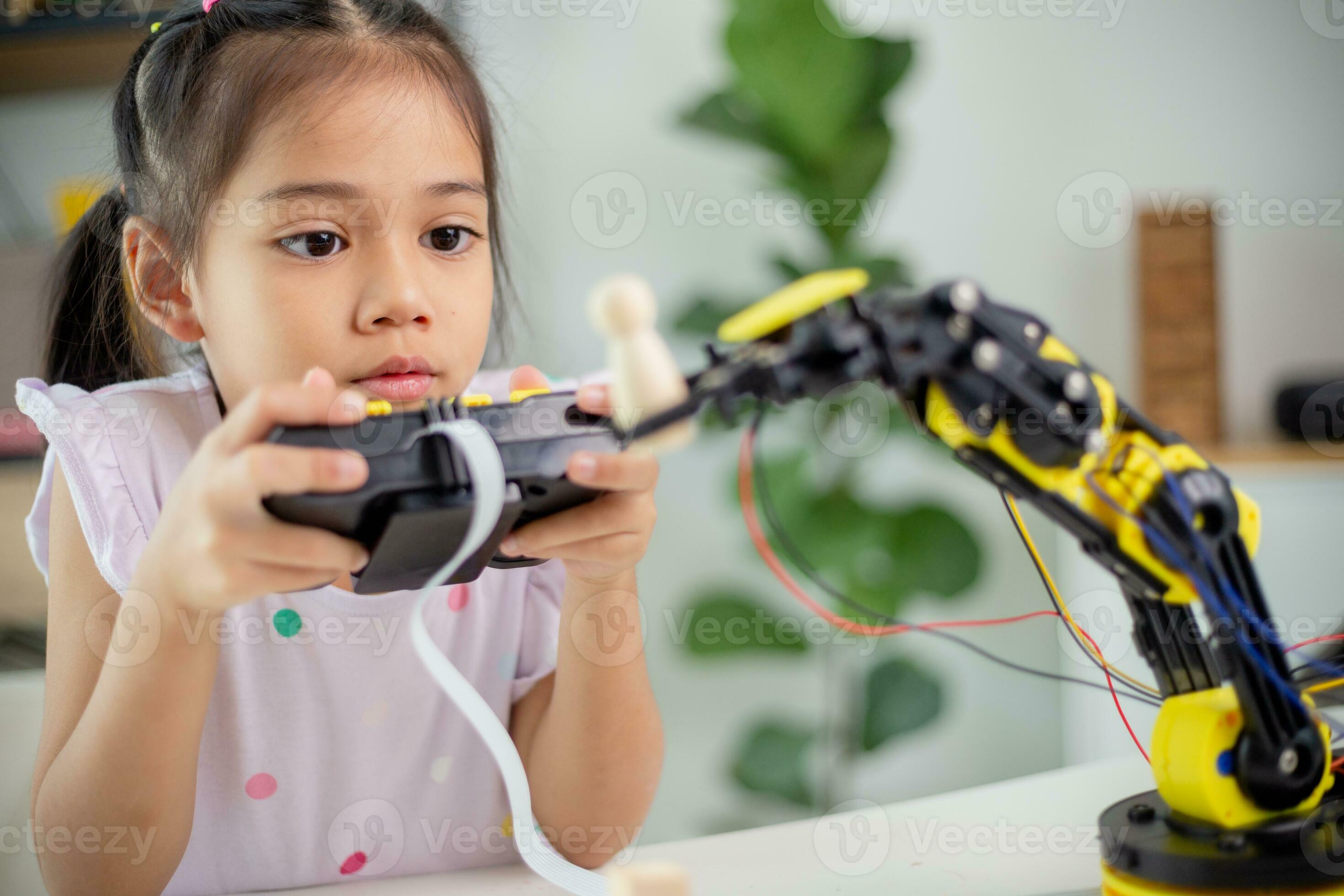STEM education concept. Asian students learn at home by coding robot arms in STEM, mathematics ...