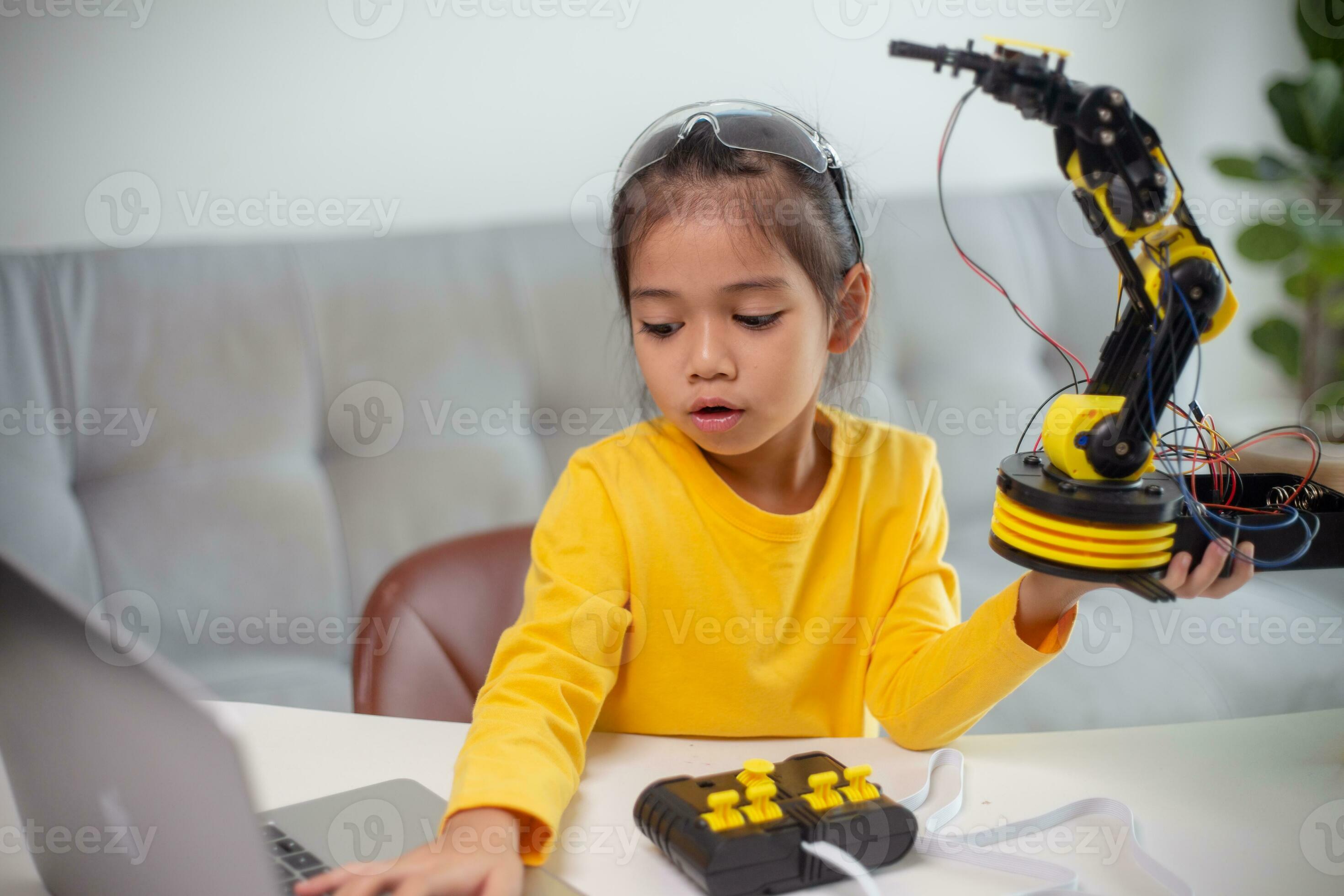 STEM education concept. Asian students learn at home by coding robot ...