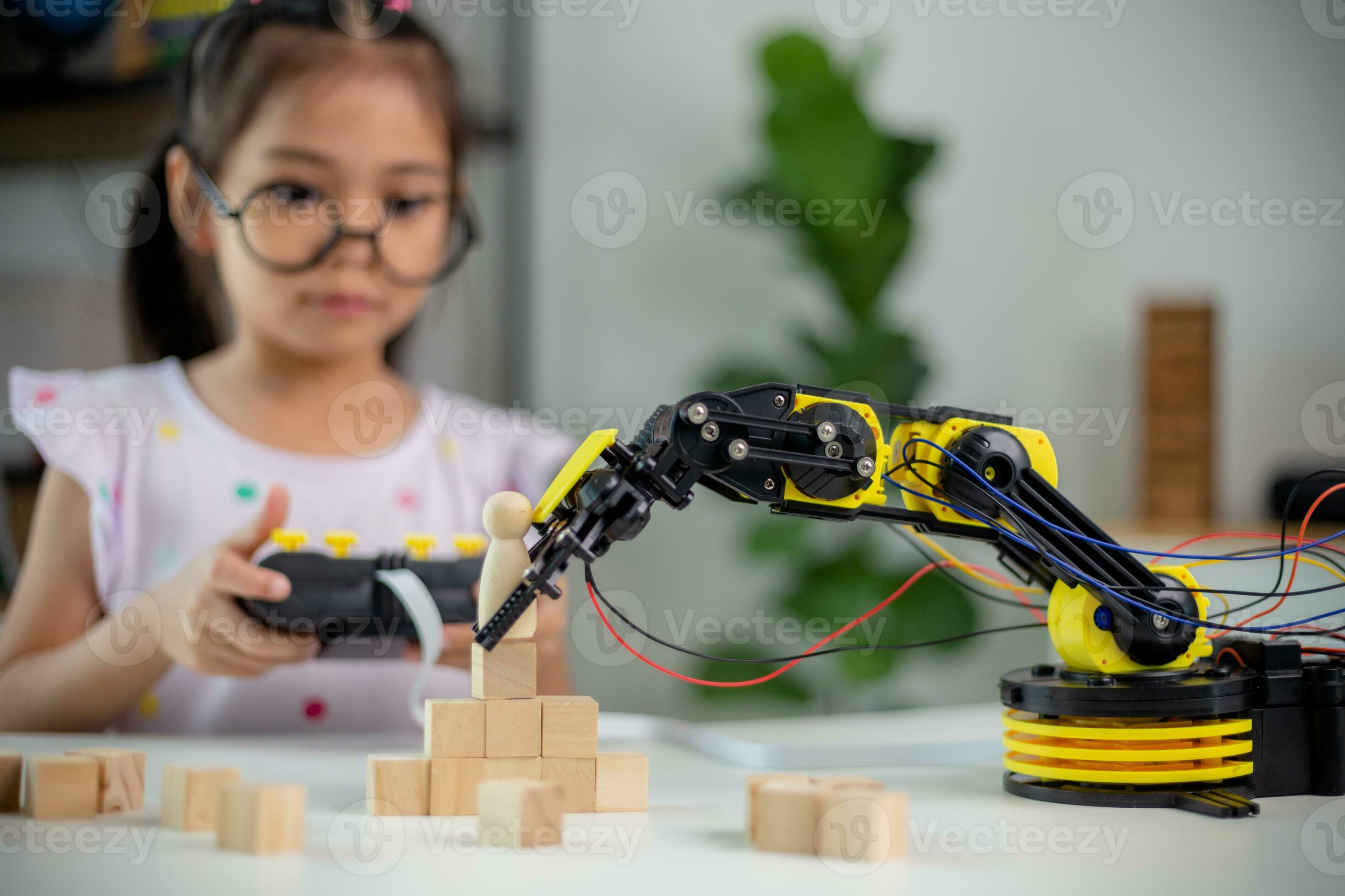 STEM education concept. Asian students learn at home by coding robot ...