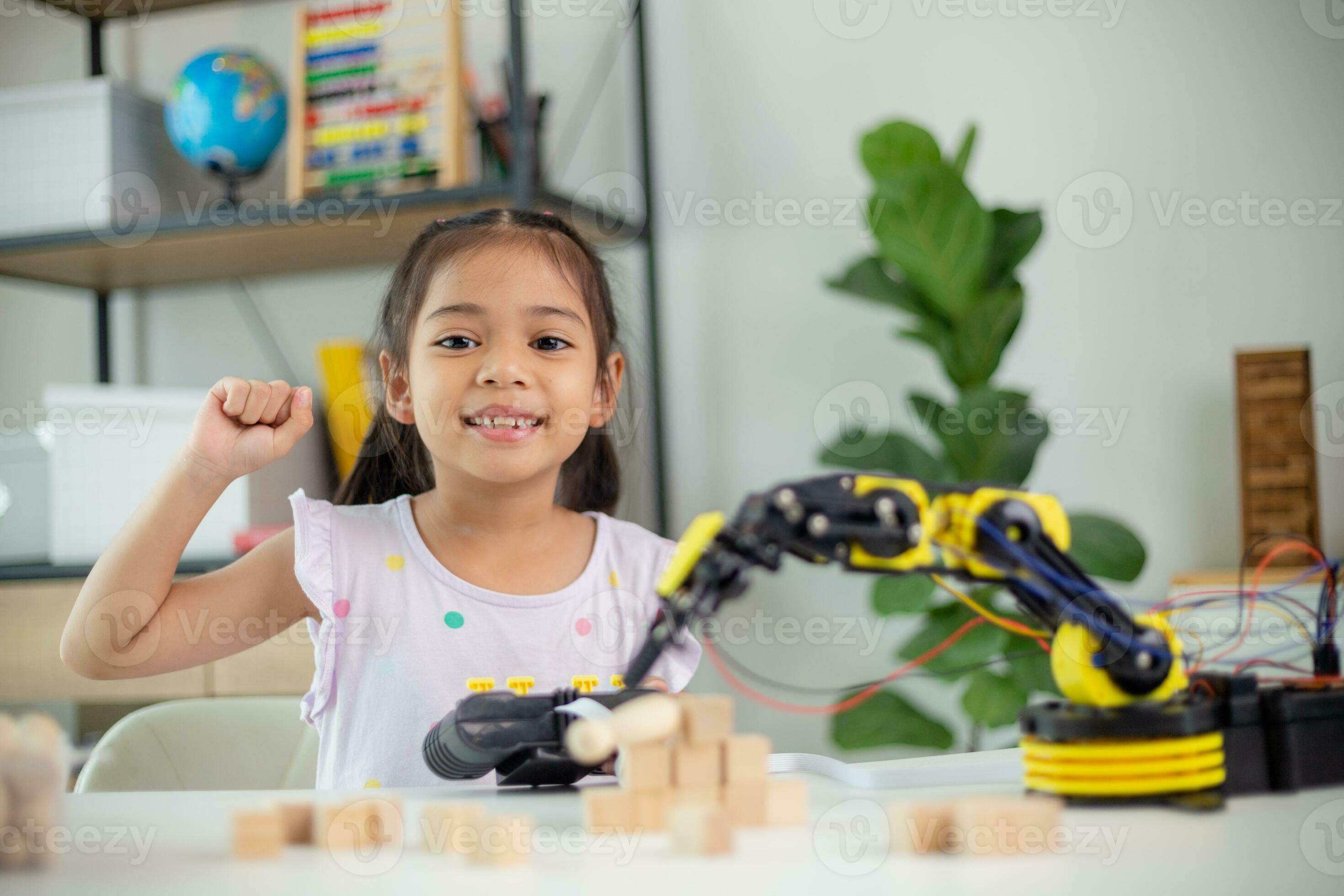 STEM education concept. Asian students learn at home by coding robot ...