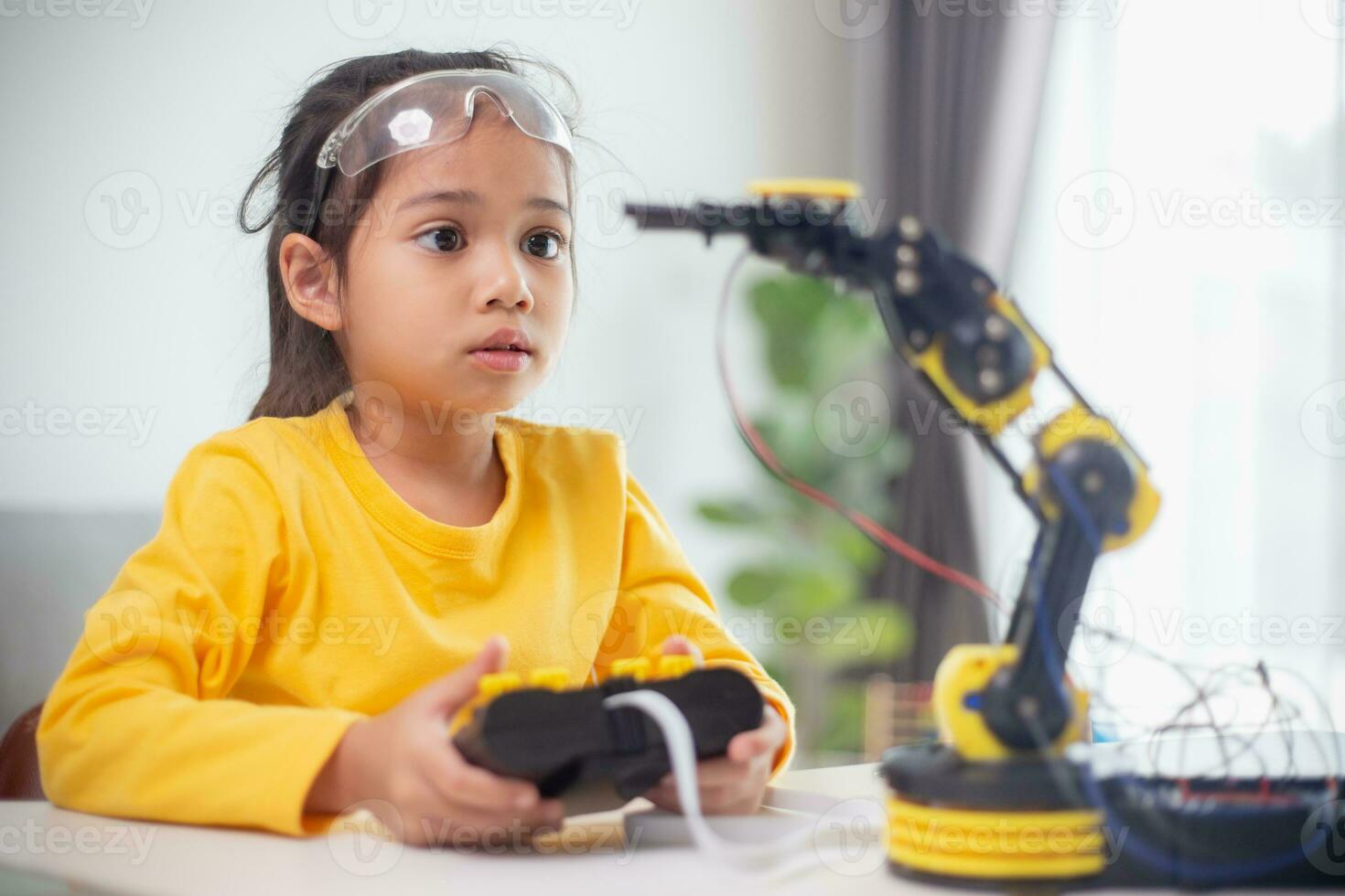 STEM education concept. Asian students learn at home by coding robot ...