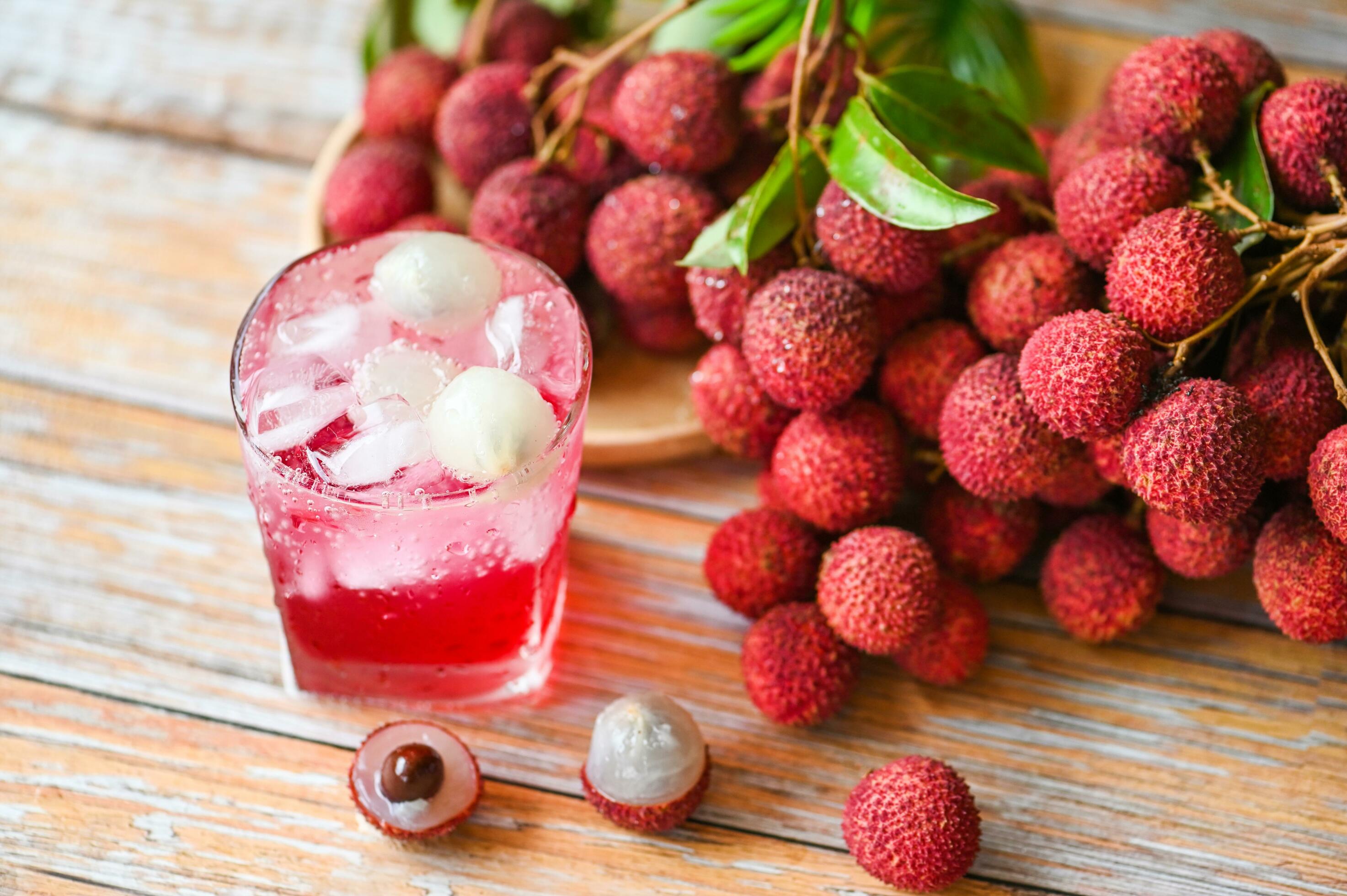 lychees on table, fresh ripe lychee fruit tropical fruit lychee juice drink with sweet soda in ...
