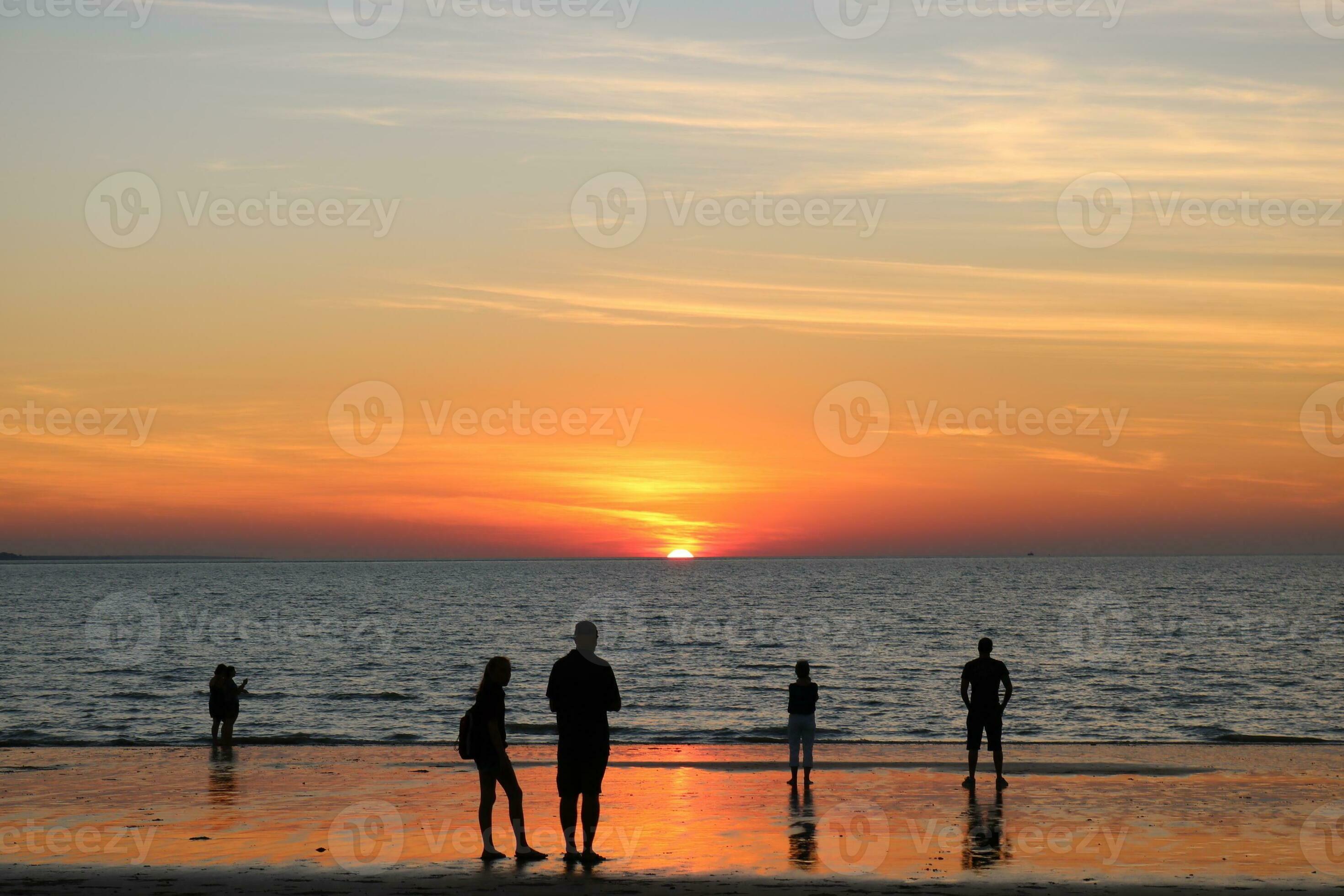 People looking at a beach sunset 24872006 Stock Photo at Vecteezy