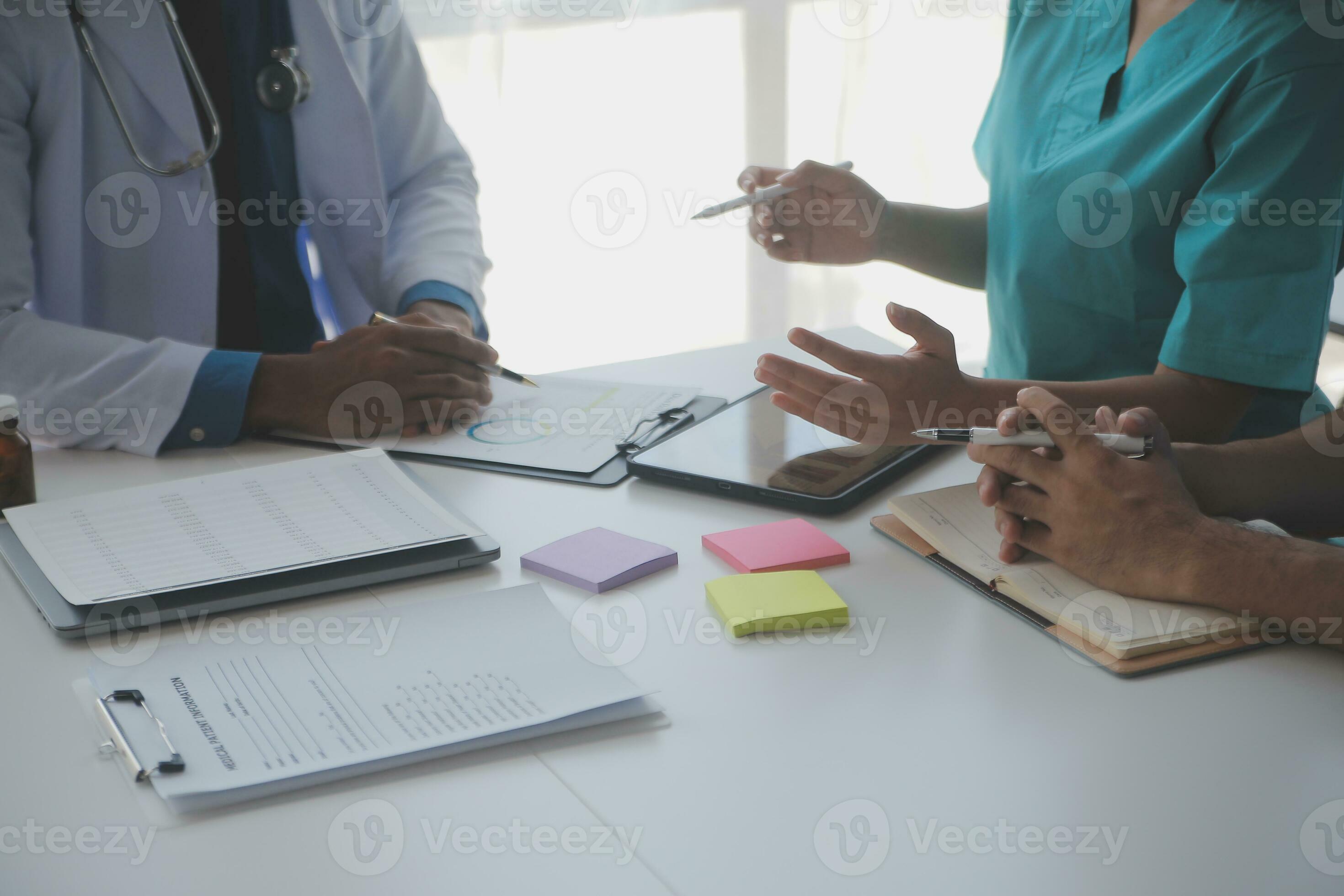 Cropped image of successful medical doctors discussing diagnosis during ... Cropped image of successful medical doctors discussing diagnosis during ...