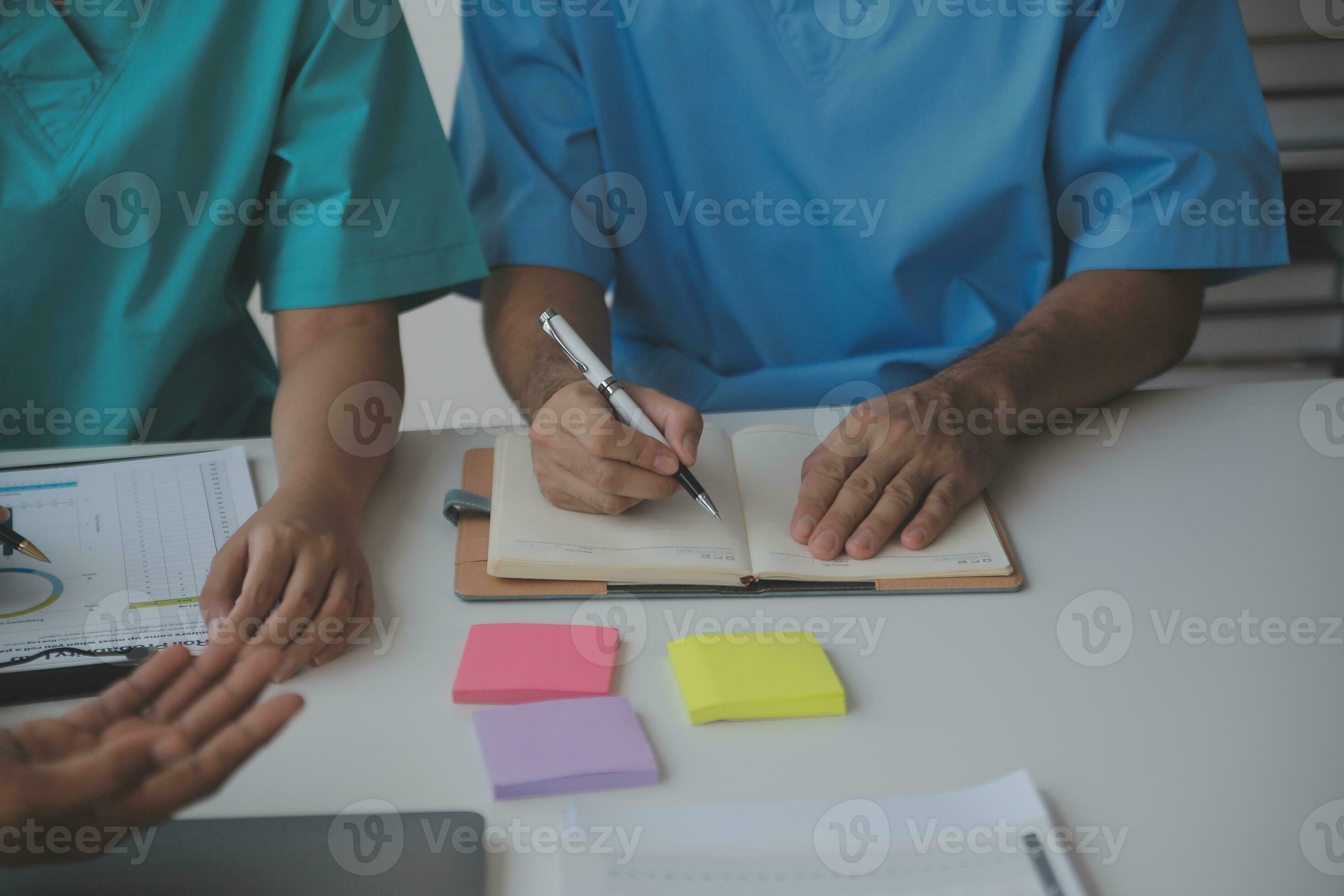 Cropped image of successful medical doctors discussing diagnosis during ... Cropped image of successful medical doctors discussing diagnosis during ...
