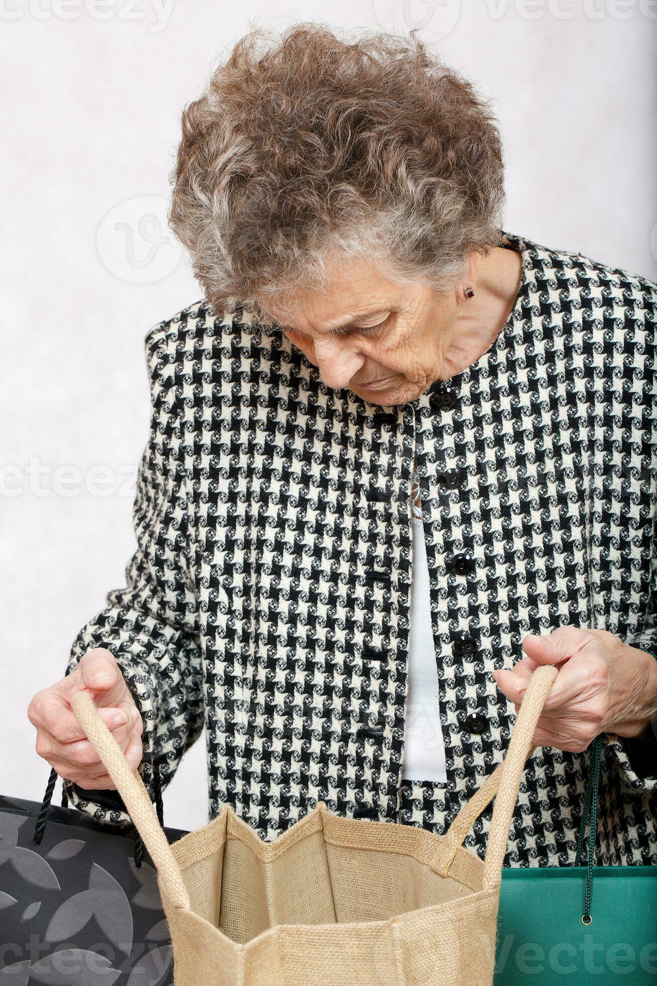 Old woman with shopping bags 24990985 Stock Photo at Vecteezy