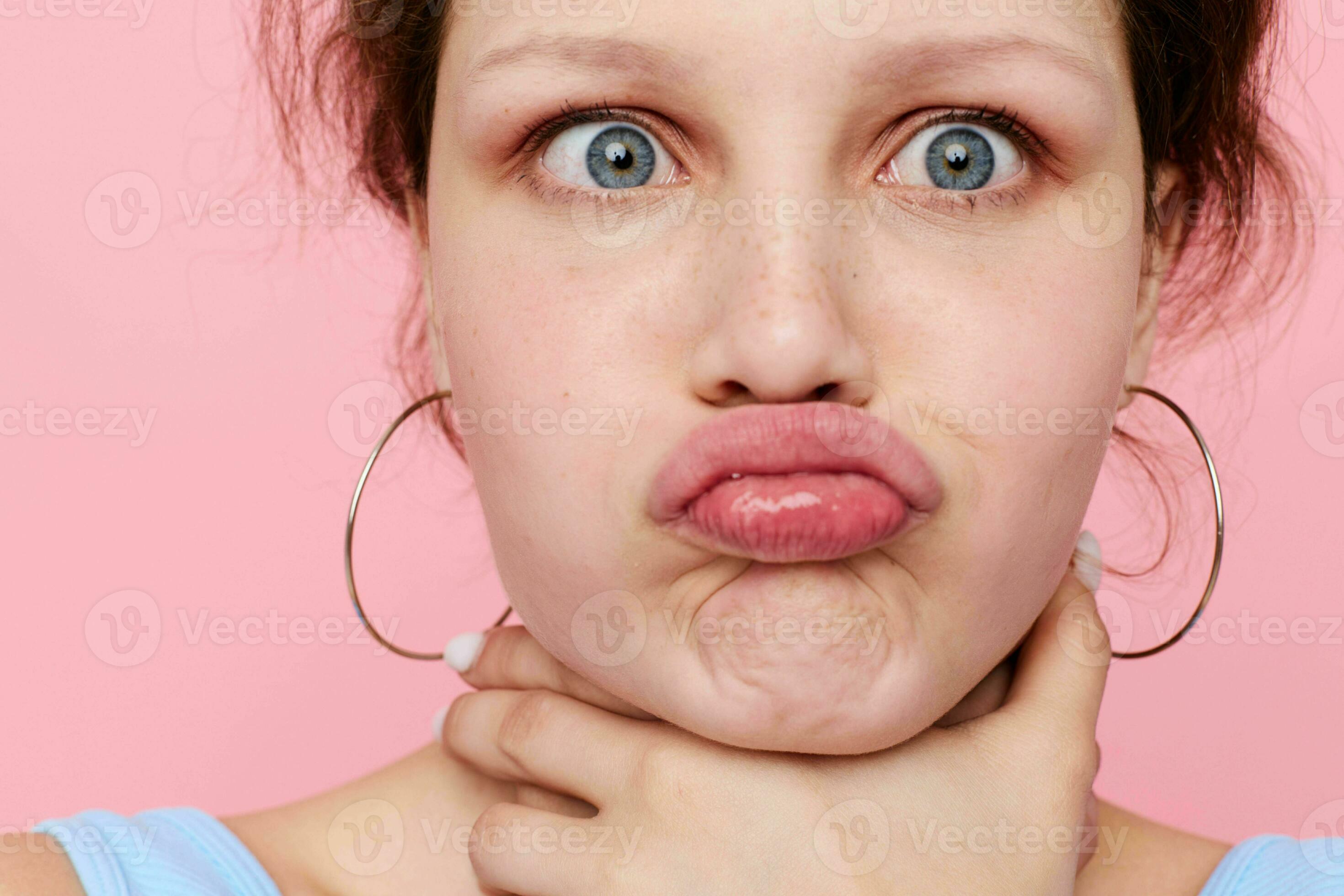 portrait of a young woman grimace close-up emotions earrings posing ...