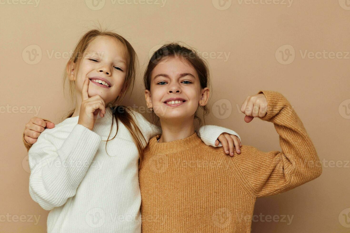 two funny little girls in sweaters posing childhood 25026624 Stock ...