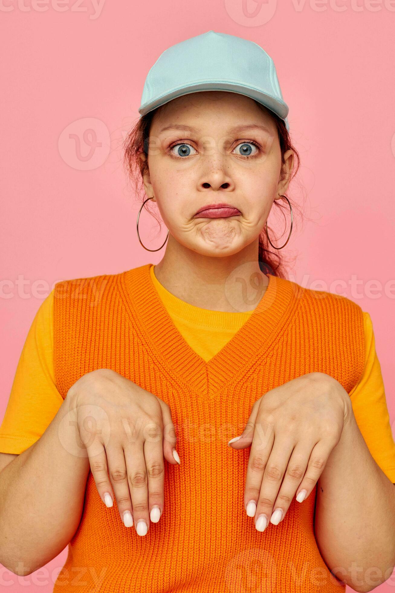 portrait of a young woman grimace earrings cap fashion isolated ...