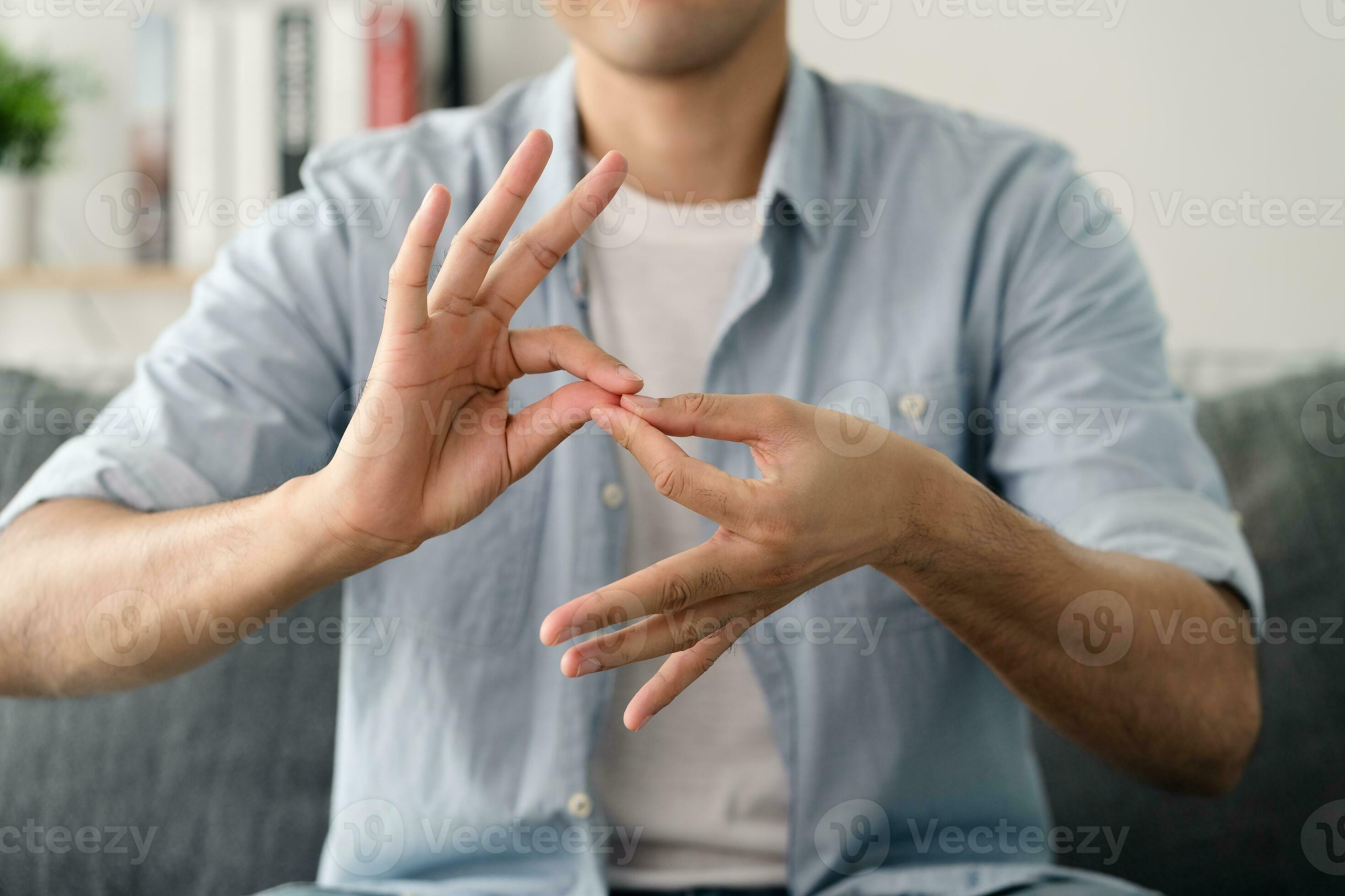 Happy young deaf man using sign Language to communicate with other ...