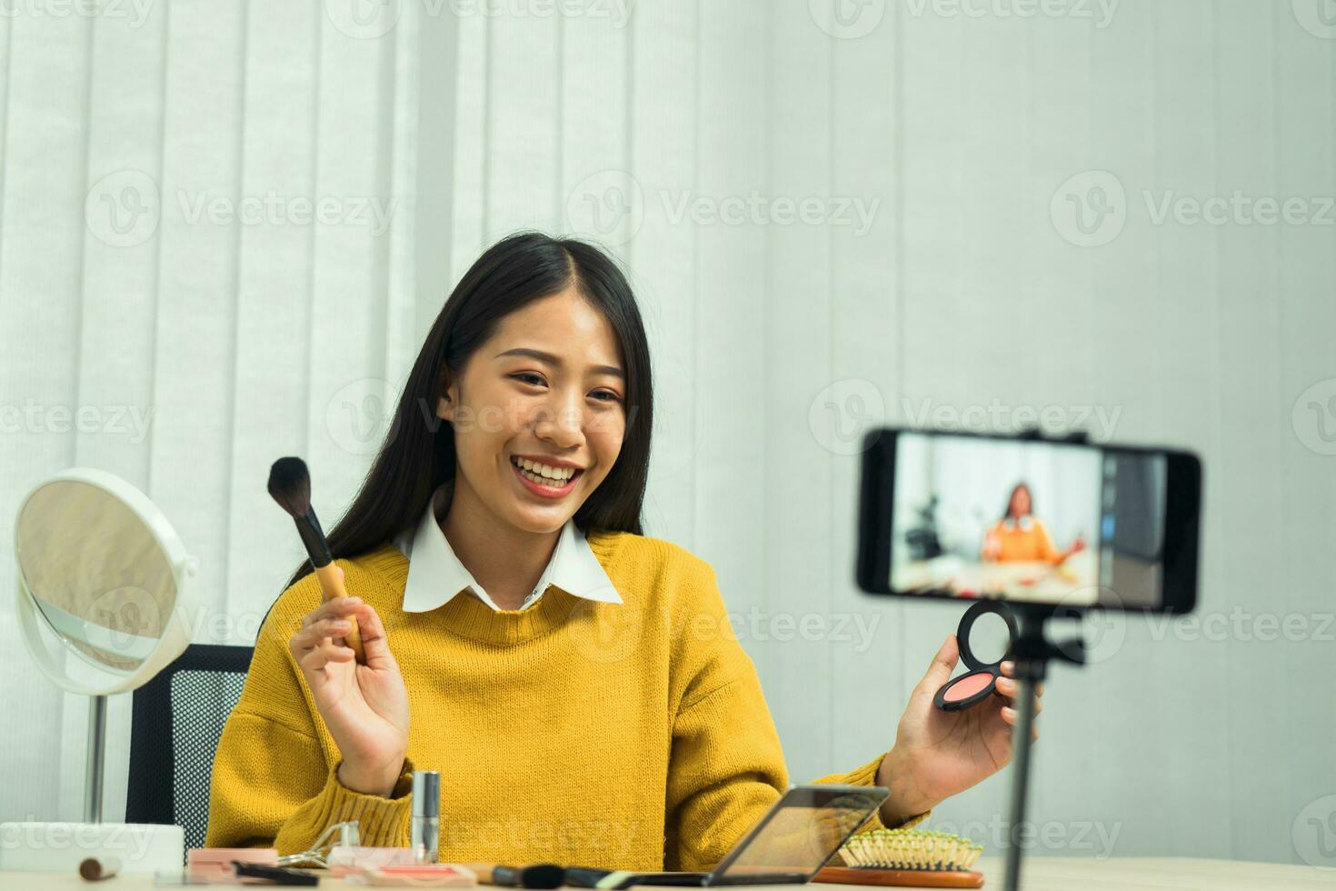 Asian teenage girls doing makeup vlogs and using a video mobile camera to record vlogs and ...