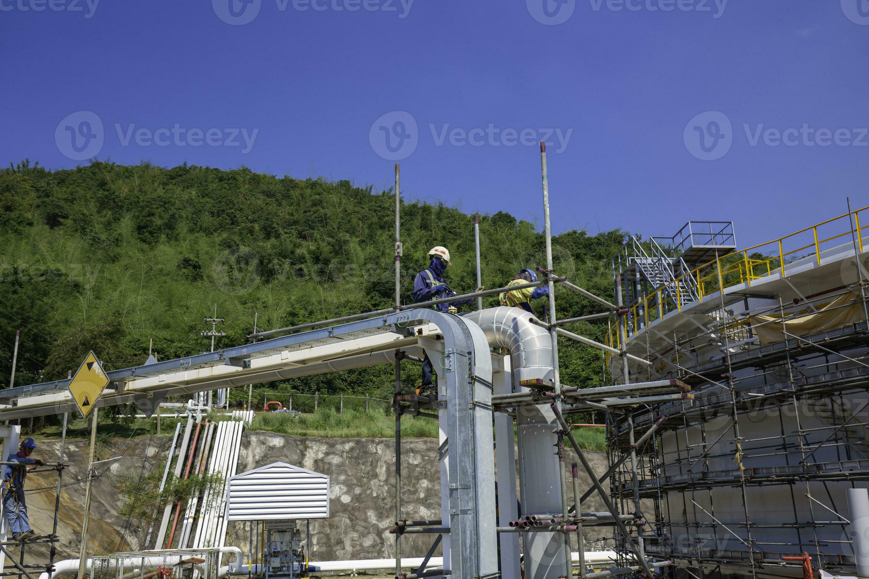 Architect on site construction workers on a scaffold pipeline 25372556 ...