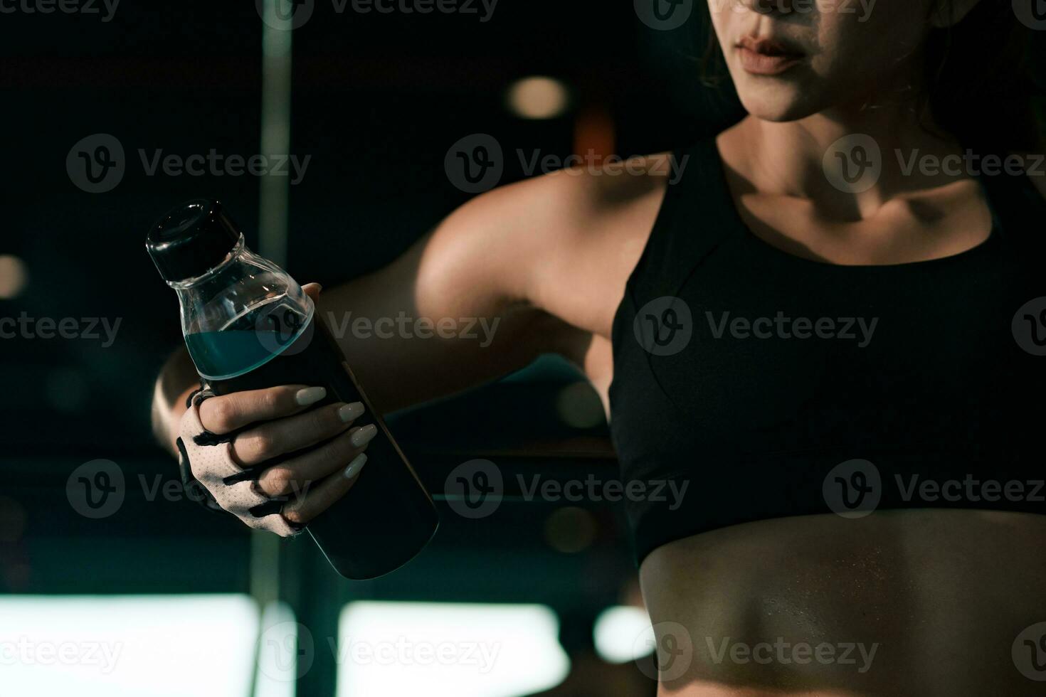 Sporty Woman Holding Water Bottle And Resting After Training In The Gym