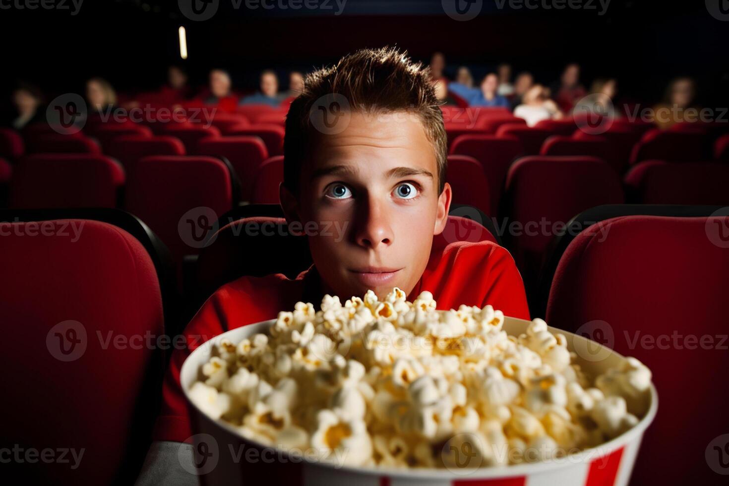 Man eating popcorn in a movie theater, sitting and eating popcorn. 25458963 Stock Photo at Vecteezy