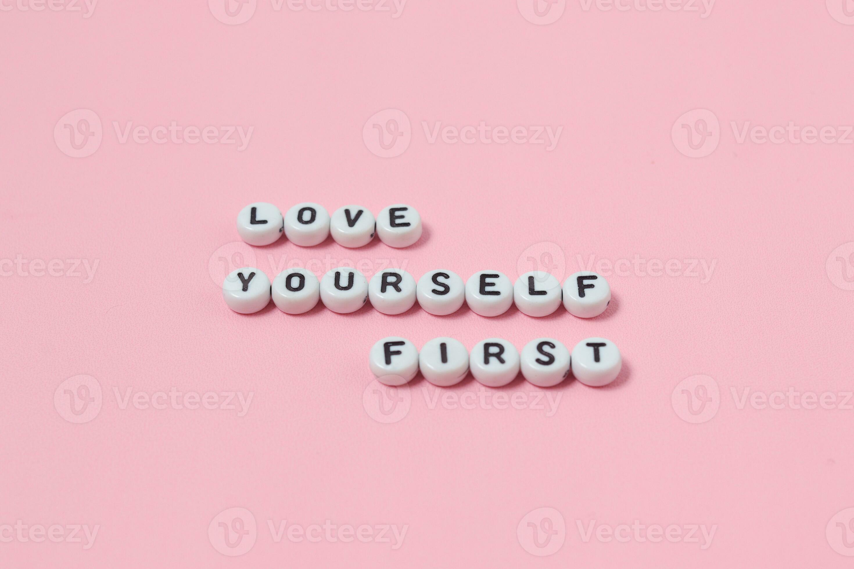 Top View Of Love Yourself First Quotes Made Out Of Beads On Pink Background Motivation And