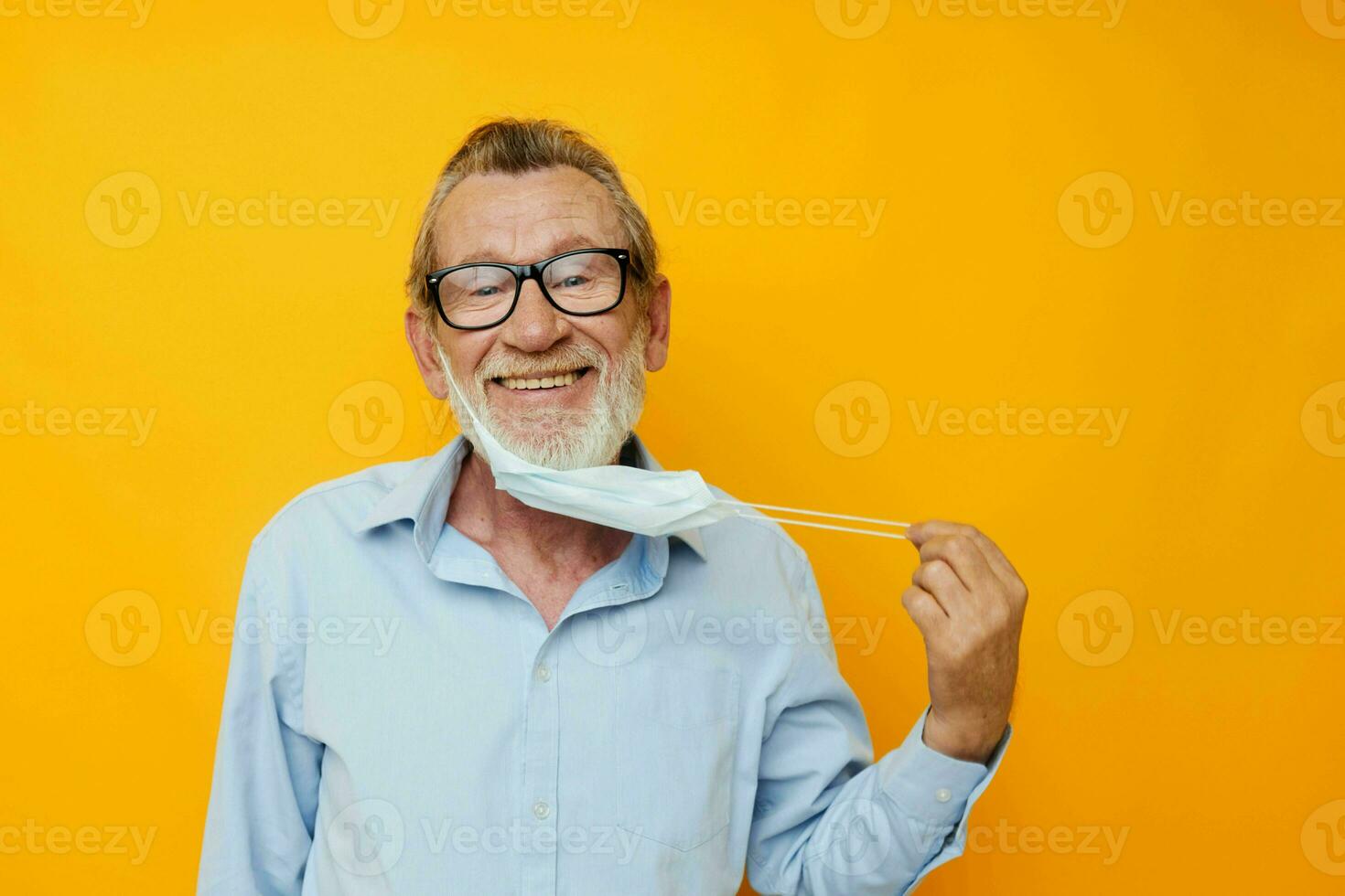 Portrait Elderly Man With Glasses Safety Medical Mask Posing Yellow
