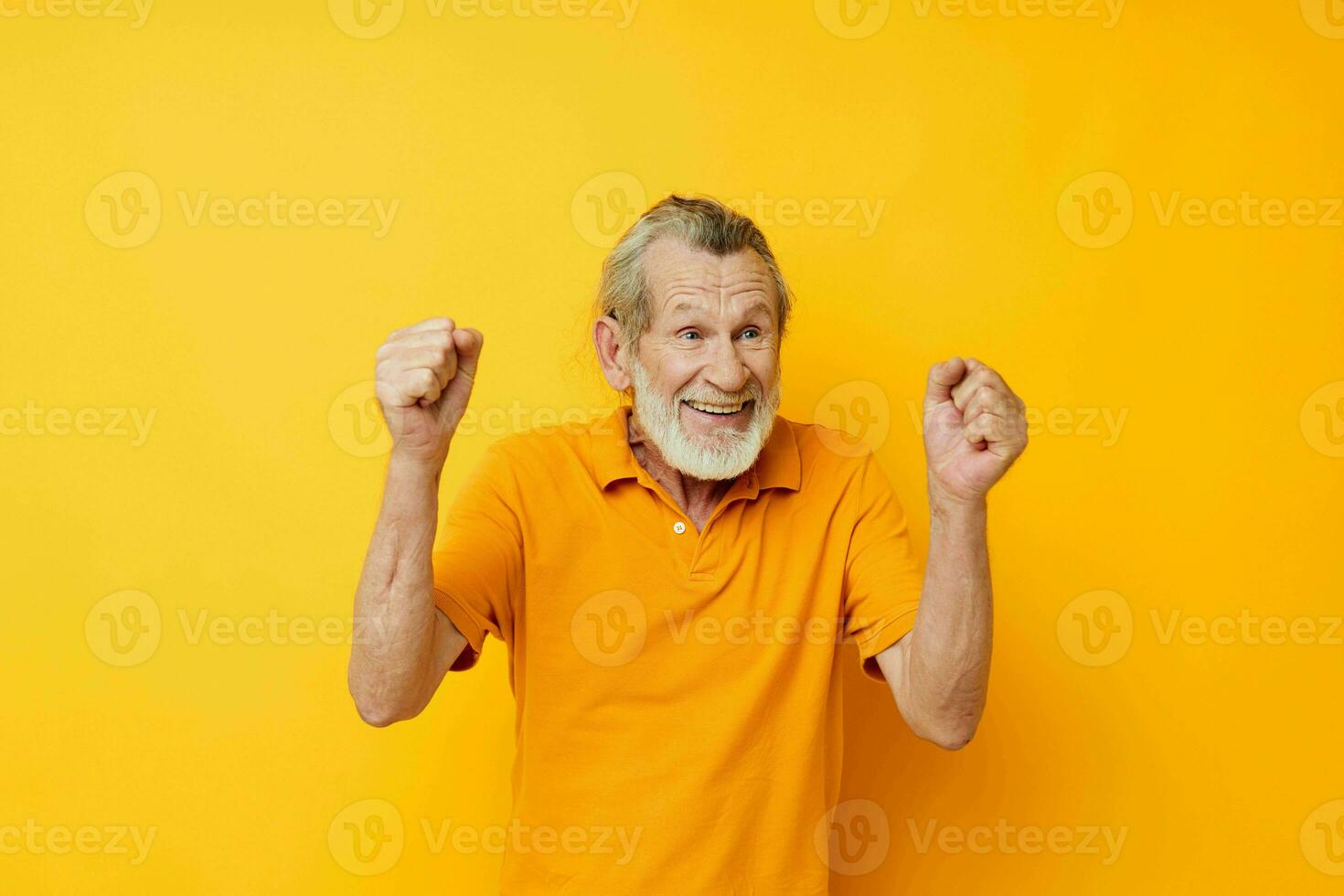 Portrait of happy senior man hand gesture gray beard fun yellow ...