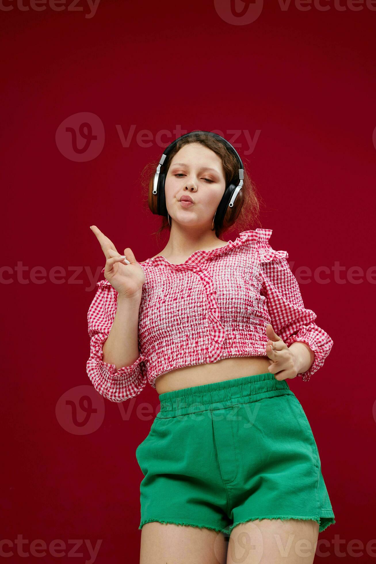 Pretty Girl In Green Shorts Moves In Headphones Listening To Music Stock Photo At Vecteezy
