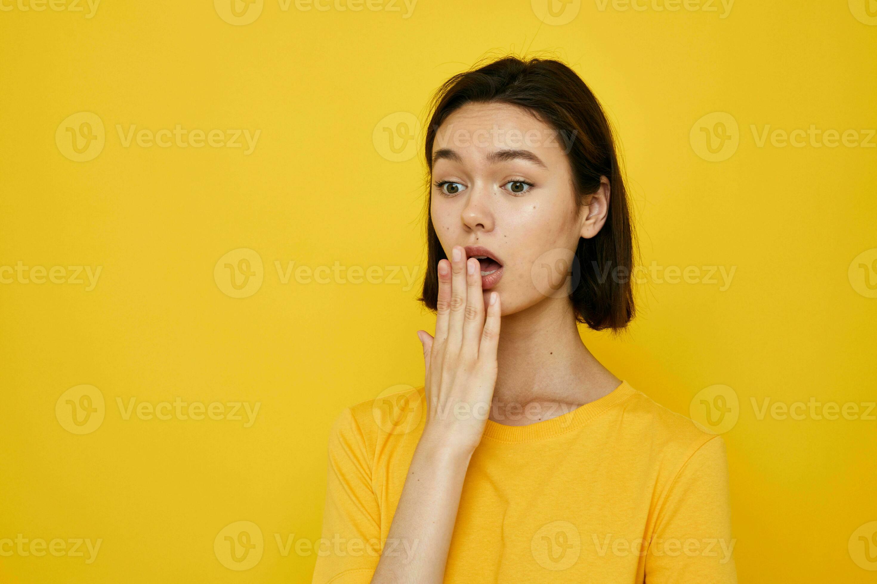 Short Haired Brunette Yellow T Shirt Summer Style Hand Gesture Yellow Background 25705869 Stock