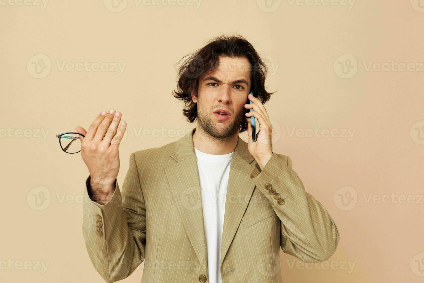 handsome man in a suit posing emotions talking on the phone isolated ... handsome man in a suit posing emotions talking on the phone isolated ...