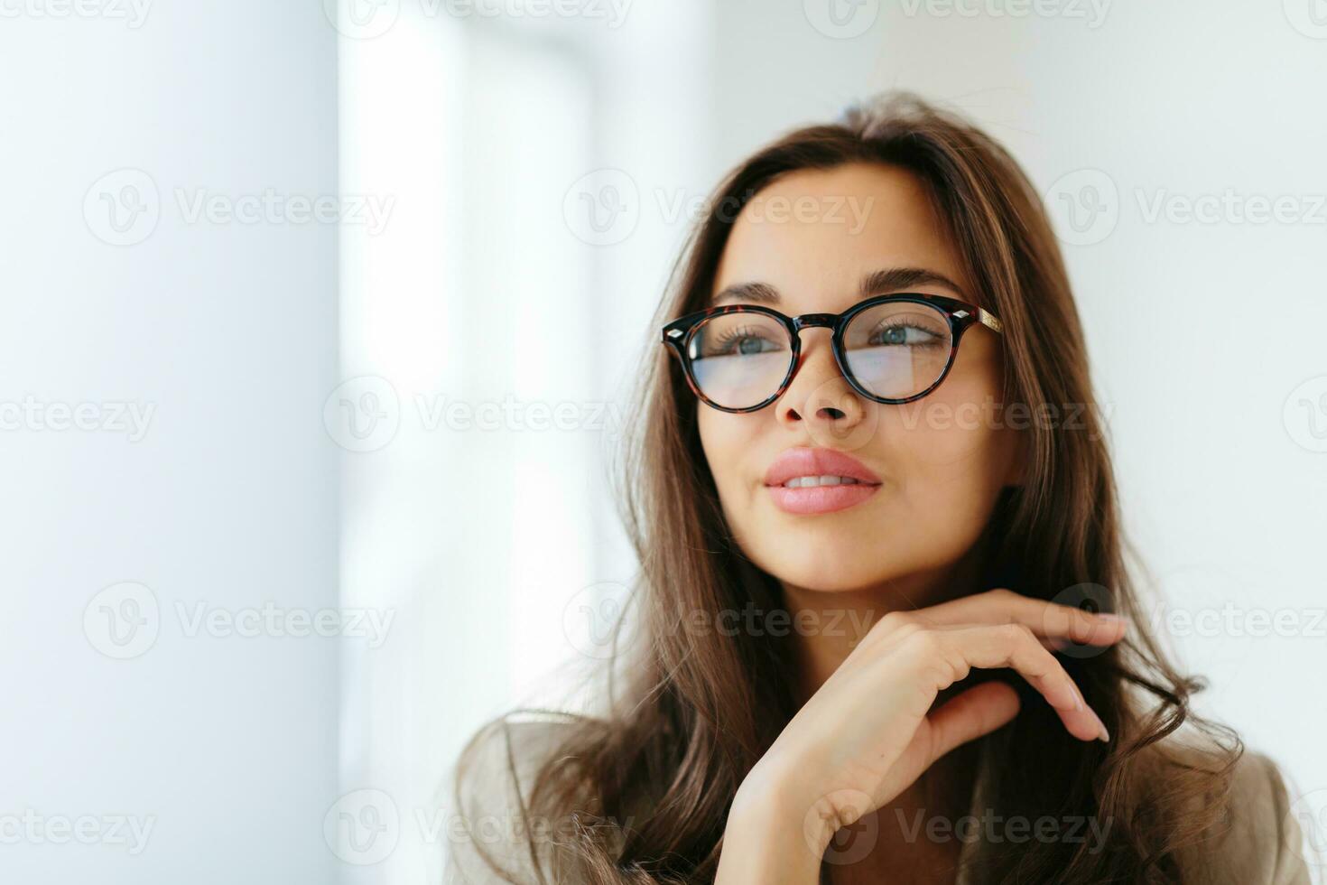 Thoughtful woman in glasses, dark hair, looking aside, touch chin, copy space. 25863878 Stock ...
