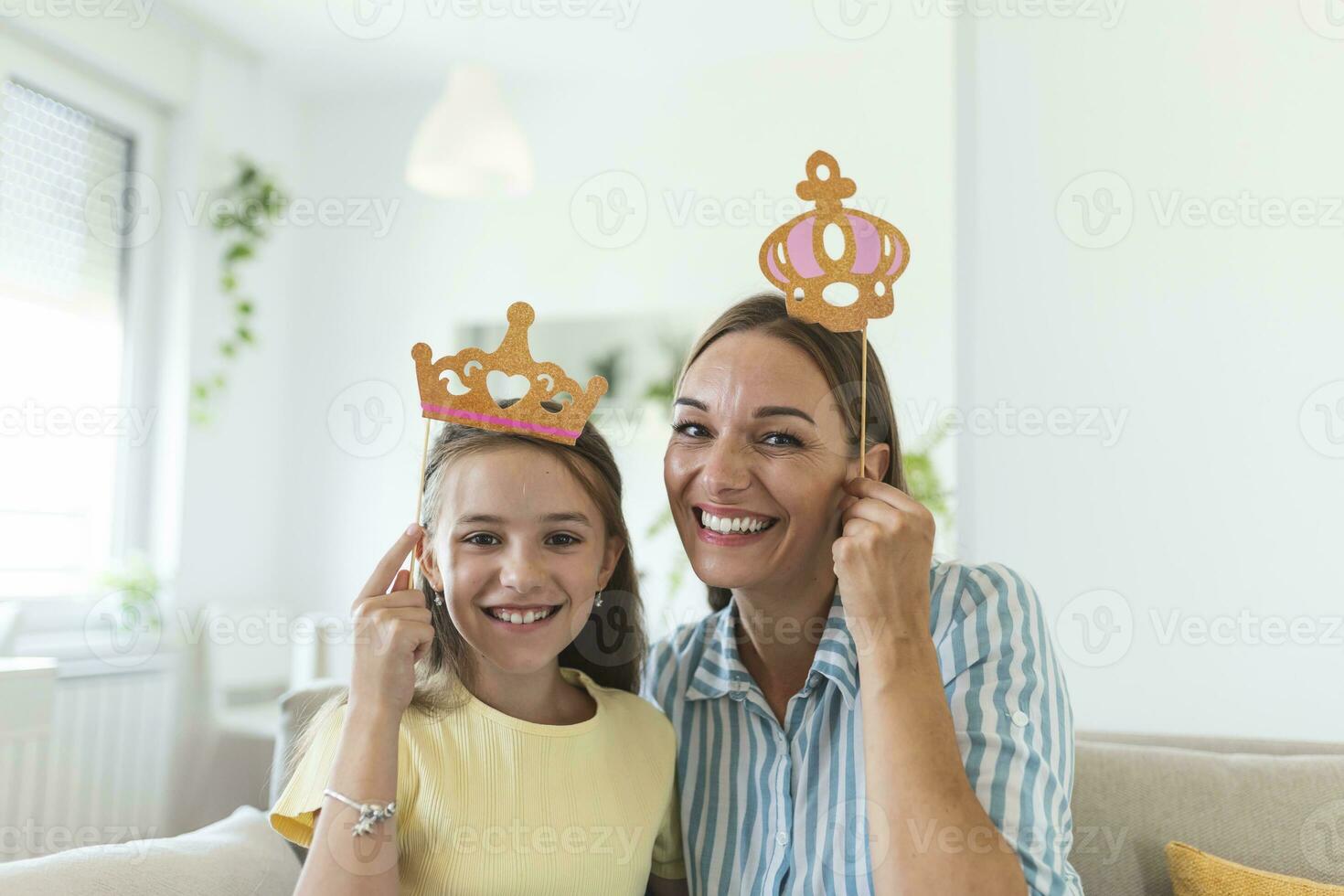 Funny family on a background of bright wall. Mother and her daughter ...