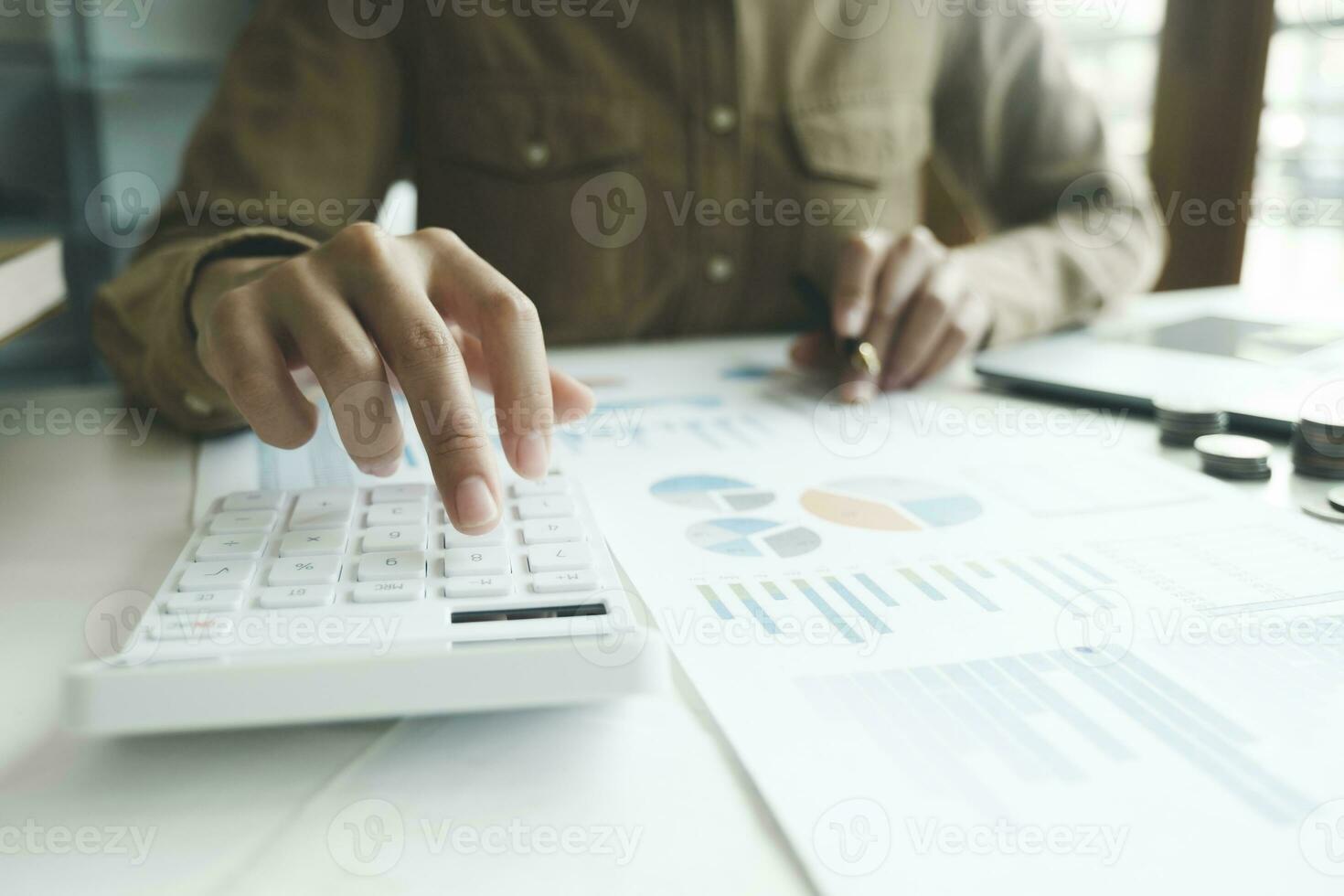 Accountant using calculator for calculate finance report in office ... Accountant using calculator for calculate finance report in office ...