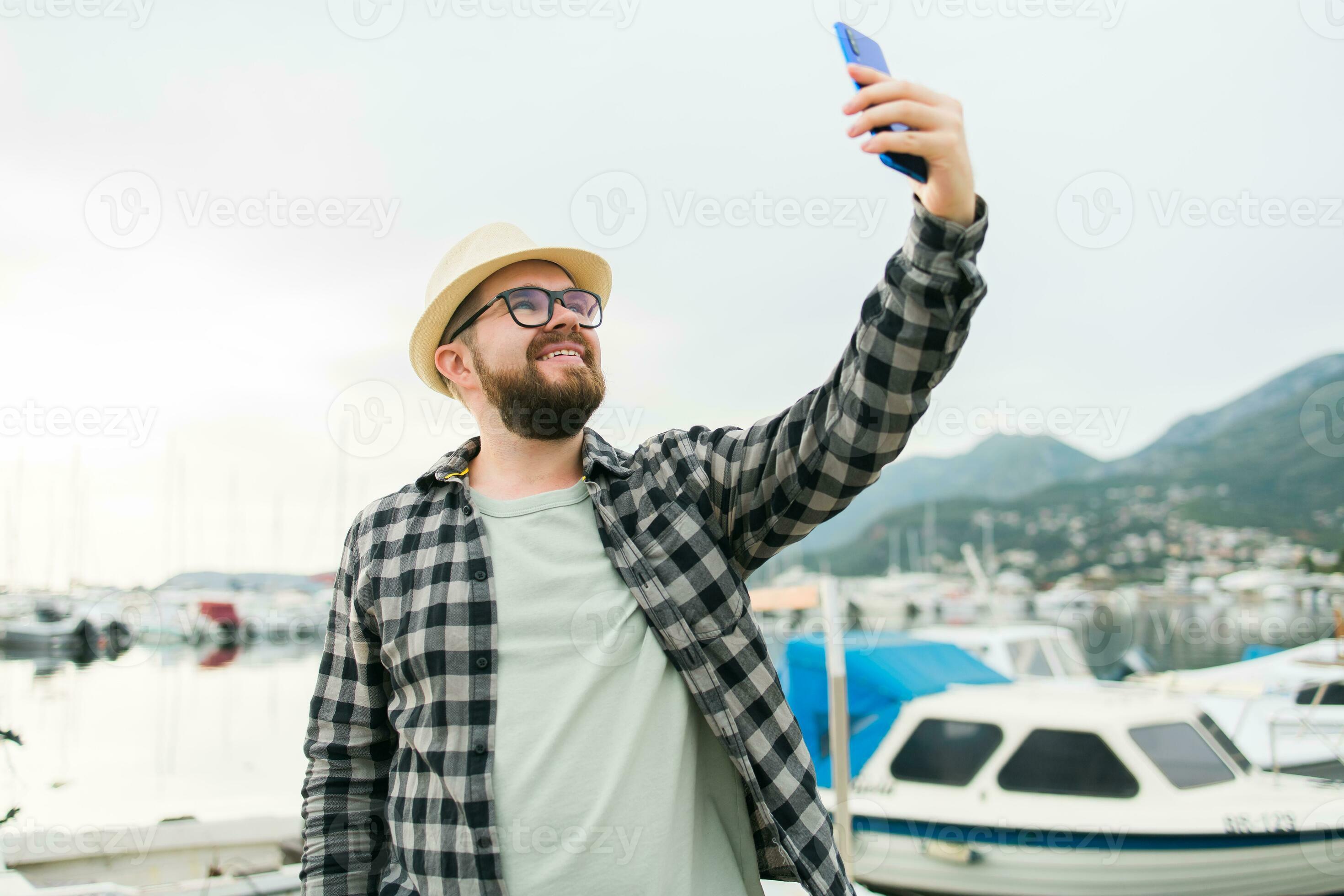 Traveller man taking selfie of luxury yachts marine during sunny day ...
