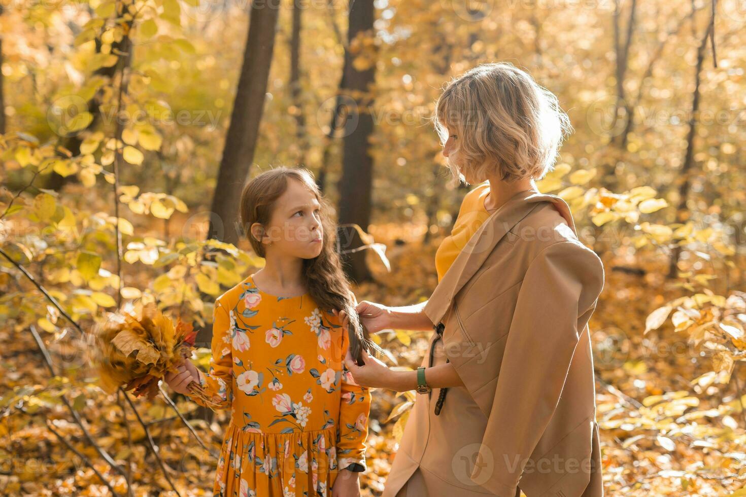 Worried mom looking at offended little daughter after family argument ...