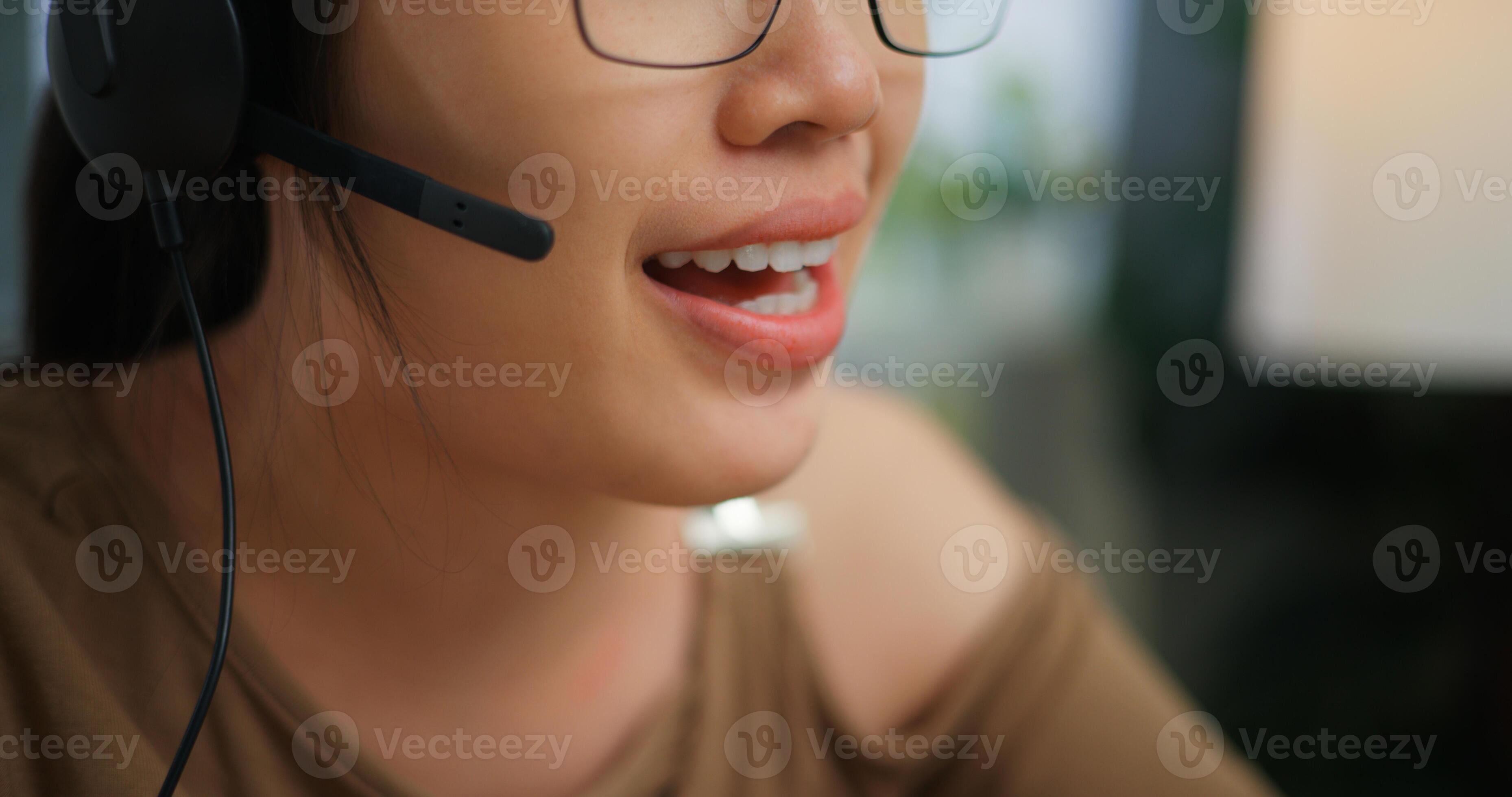 Young Asian woman wearing glasses using a laptop on a desk 26275989 ...