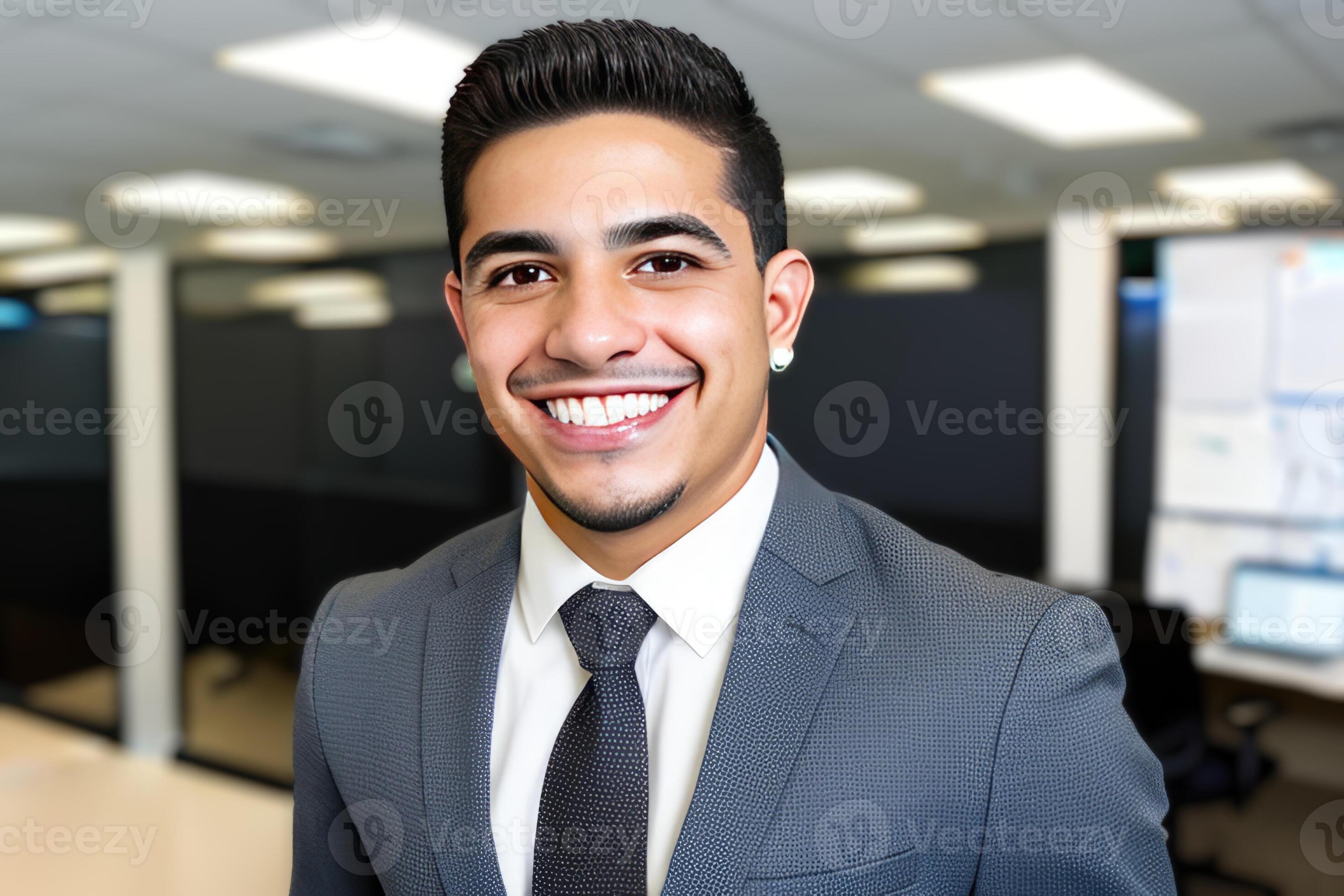 Young smart businessman, standing in blur background of office ...