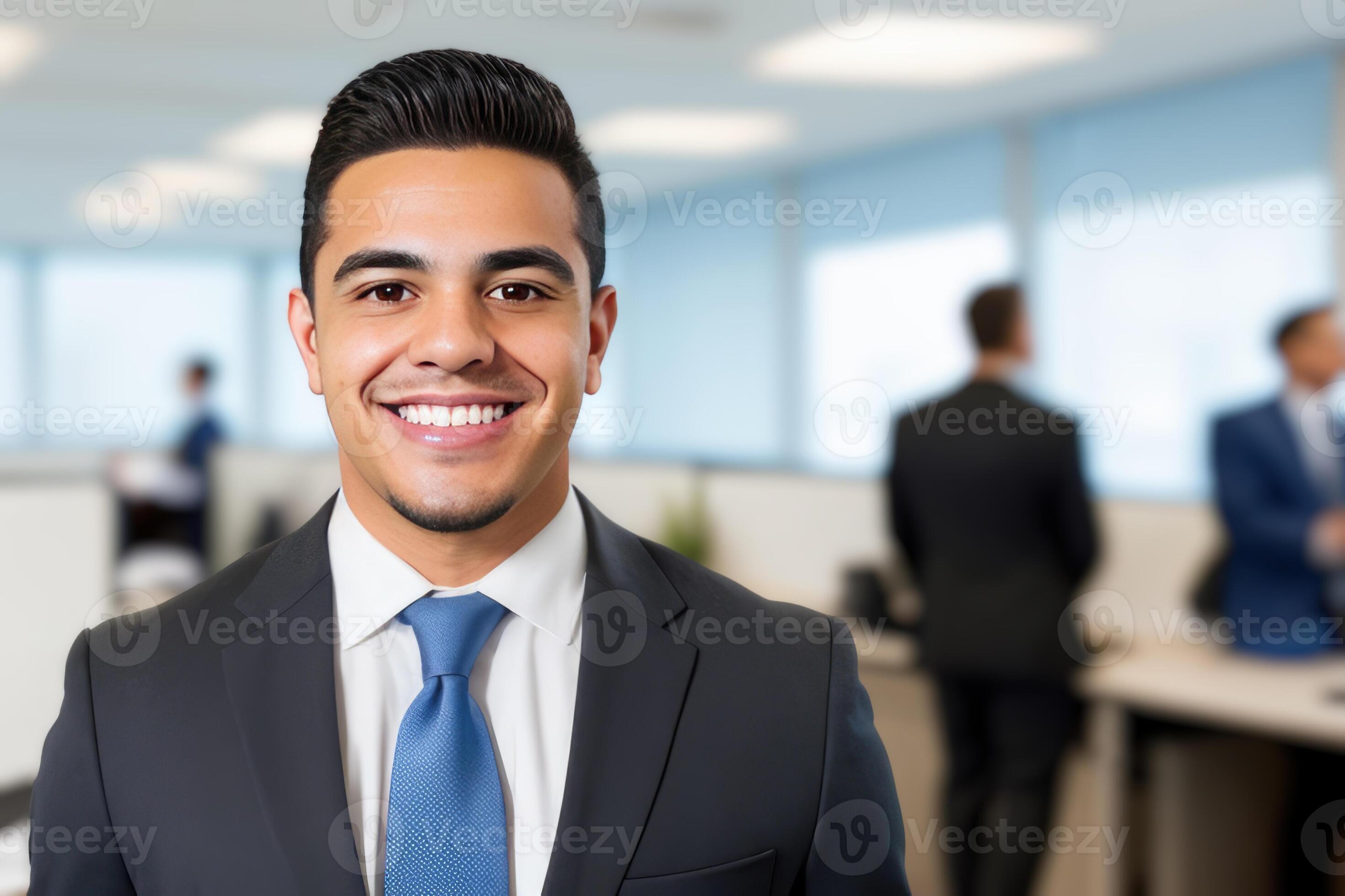 Young smart businessman, standing in blur background of office ...