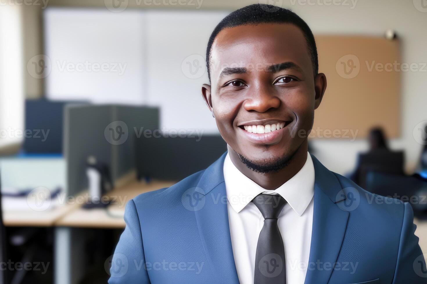 Young smart businessman, standing in blur background of office ...