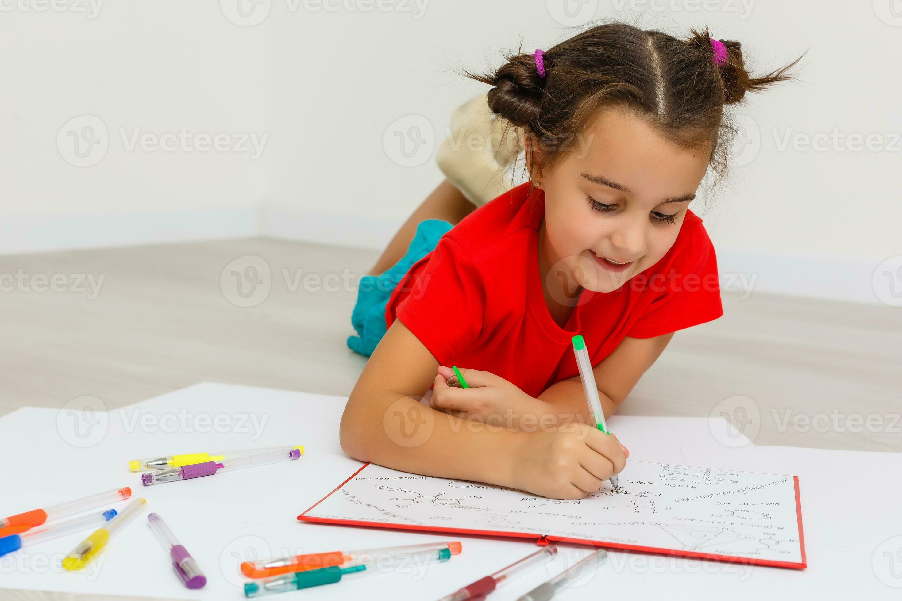 Education at home concept - Cute little girl studying with pile of books on the floor at home ...