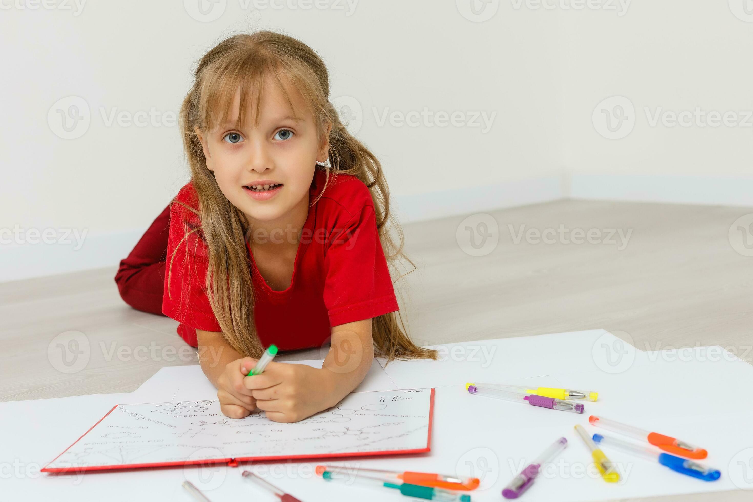 Education at home concept - Cute little girl studying with pile of books on the floor at home ...