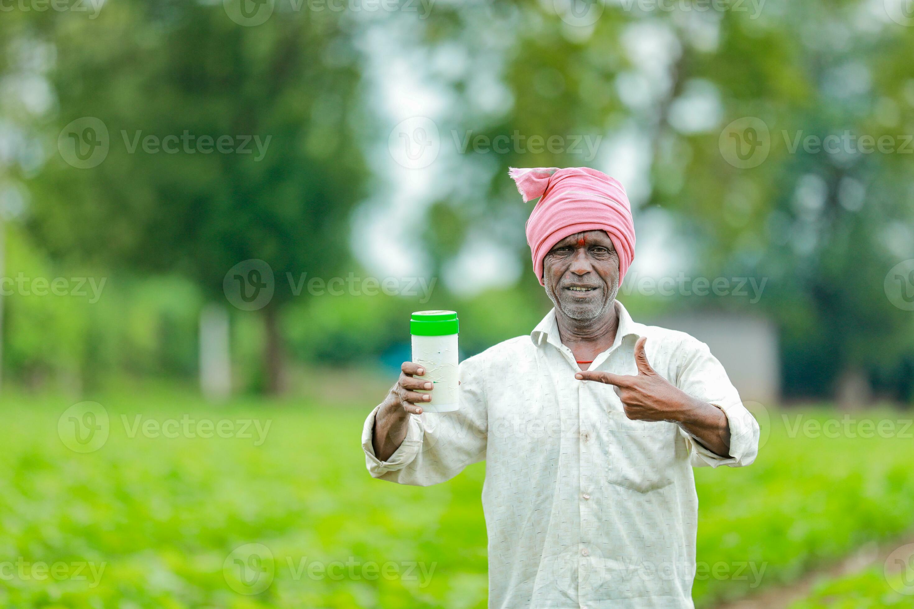Indian happy farmer holding empty Bottle in hands, happy farmer showing ... Indian happy farmer holding empty Bottle in hands, happy farmer showing ...