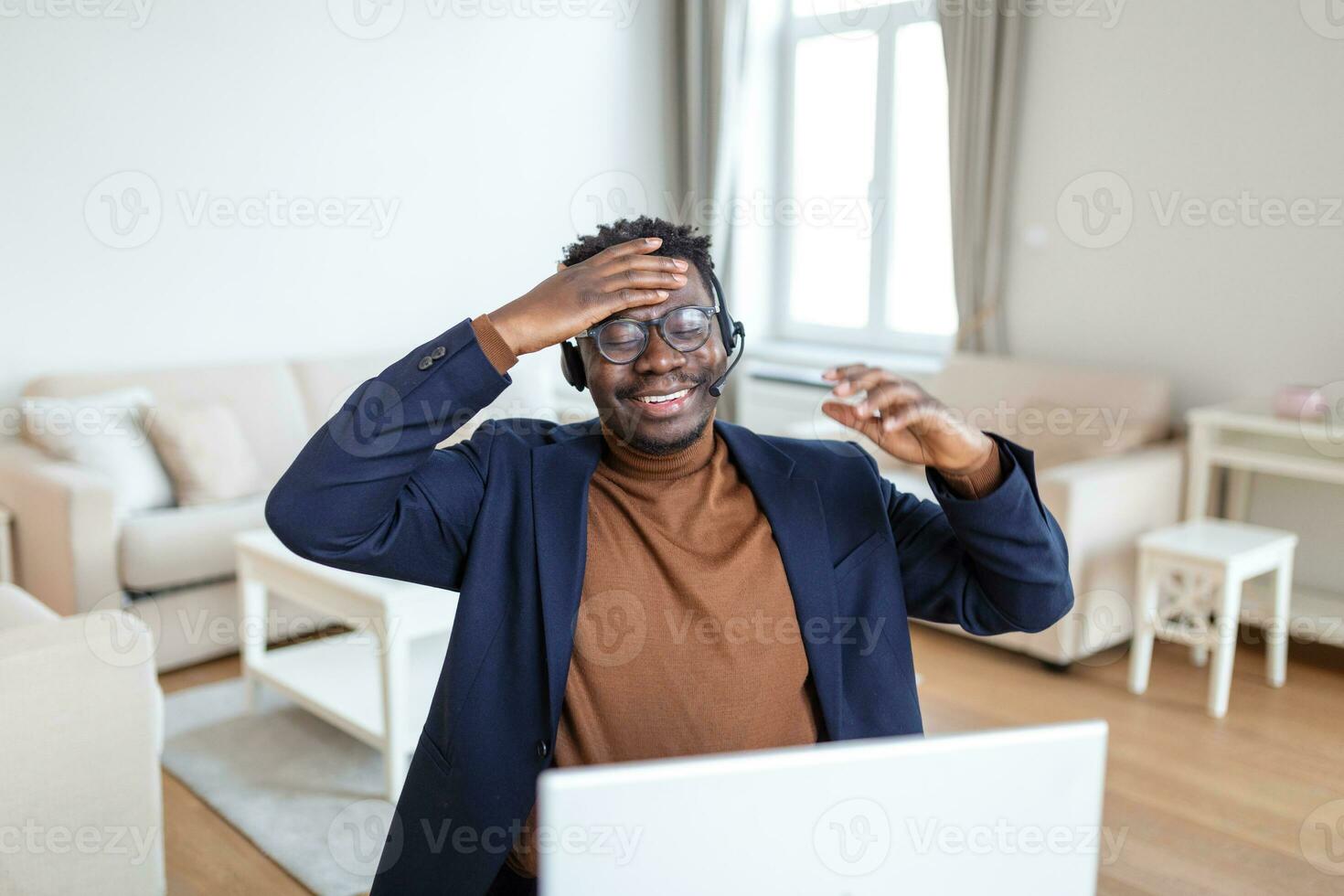 Excited Biracial Male Call Center Agent In Headset Have Fun Laugh Working On Computer Online