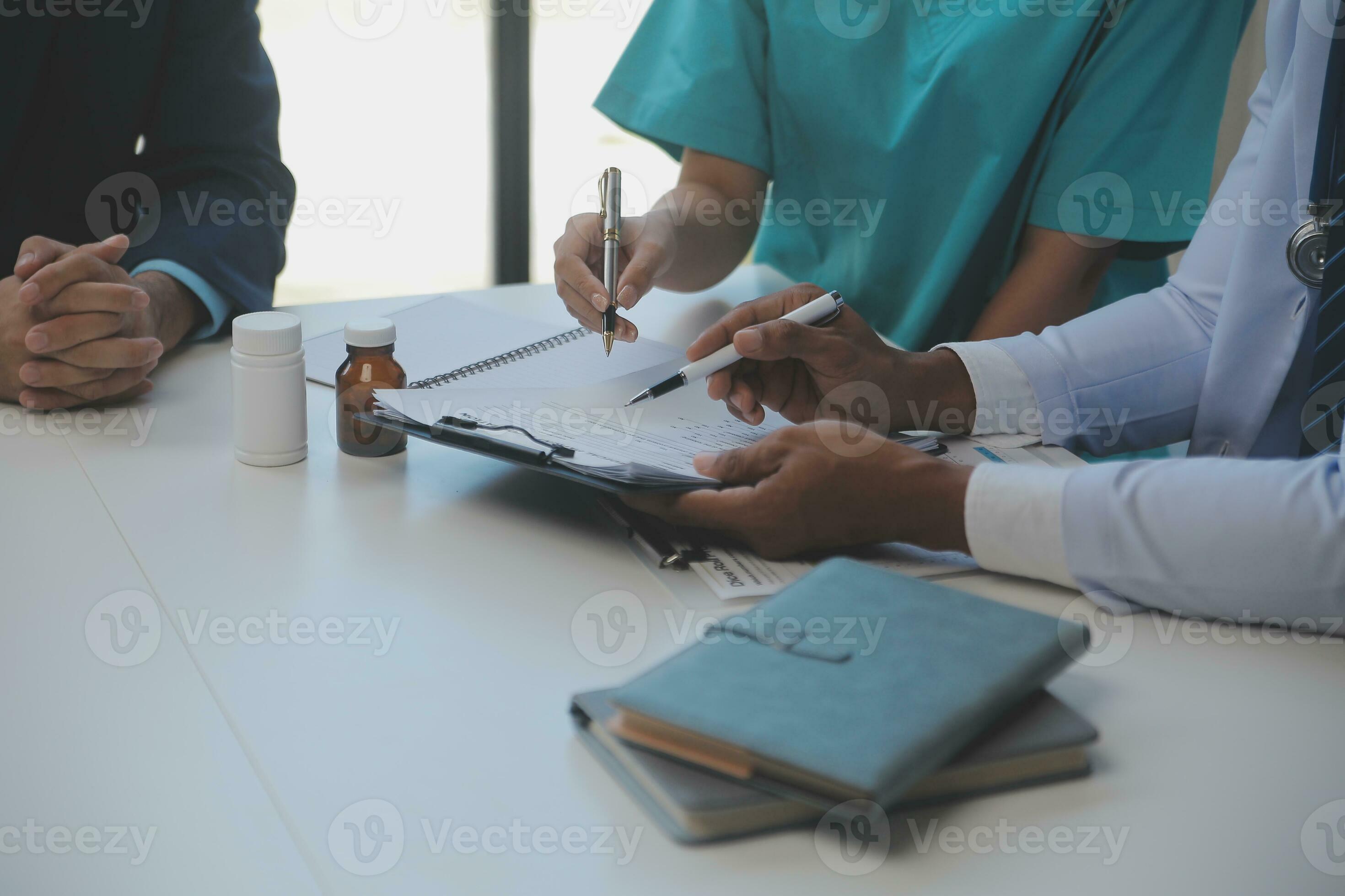 Cropped image of successful medical doctors discussing diagnosis during ... Cropped image of successful medical doctors discussing diagnosis during ...