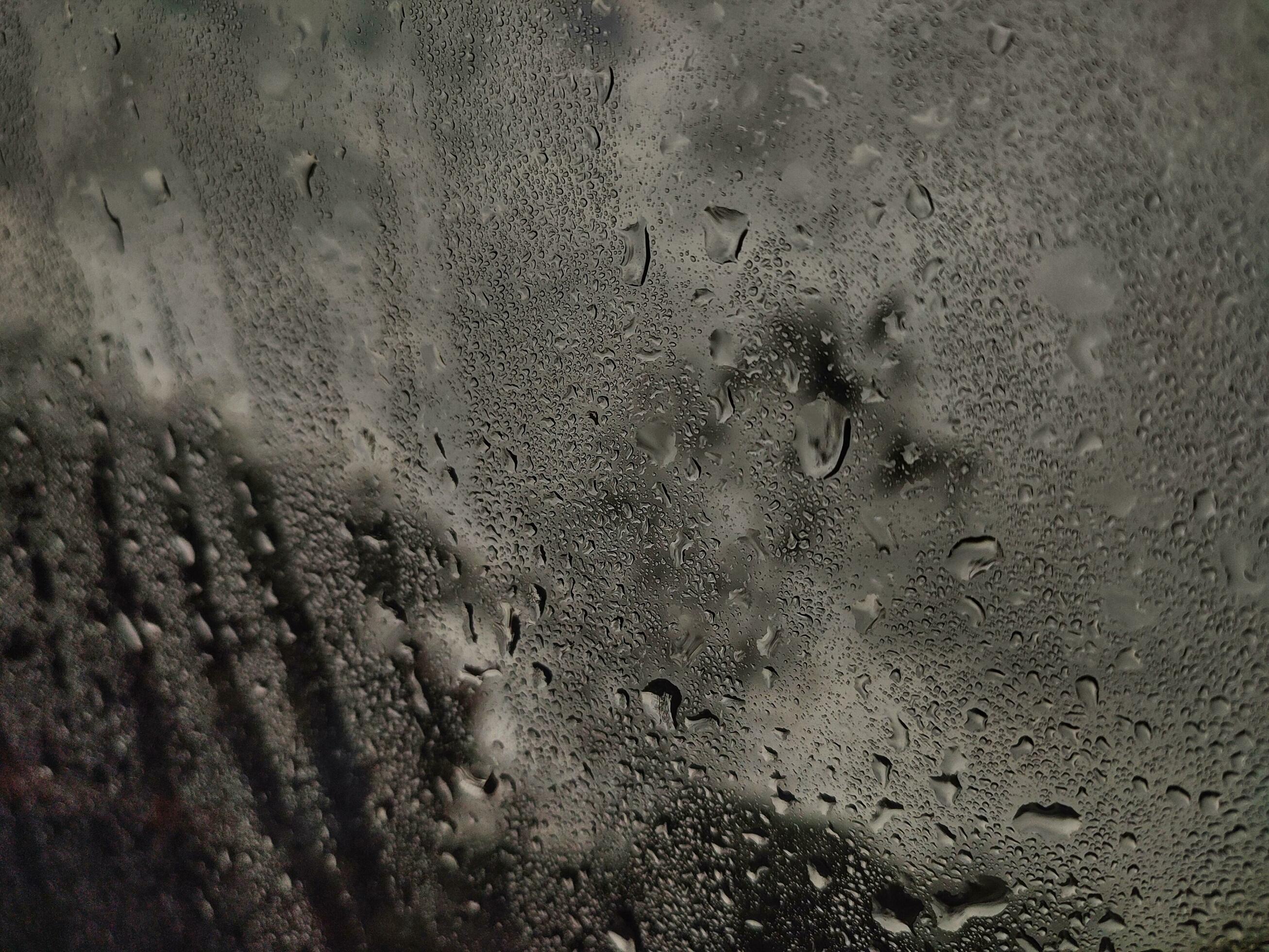Abstract background of drops of water flow down at windshield. 26575932 ...