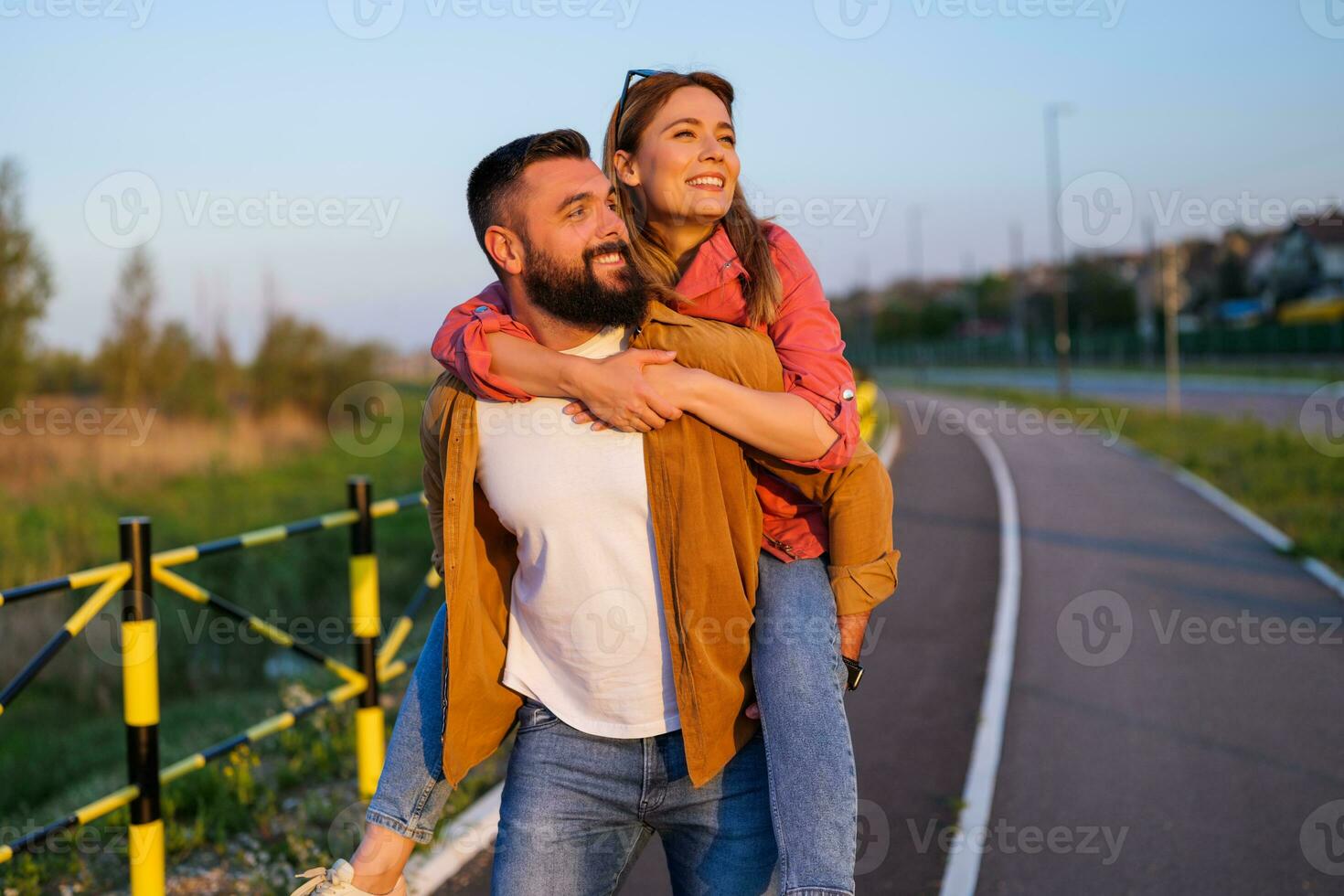 Happy Smiling Couple Enjoying Sunset Man Is Carrying On Back His Woman