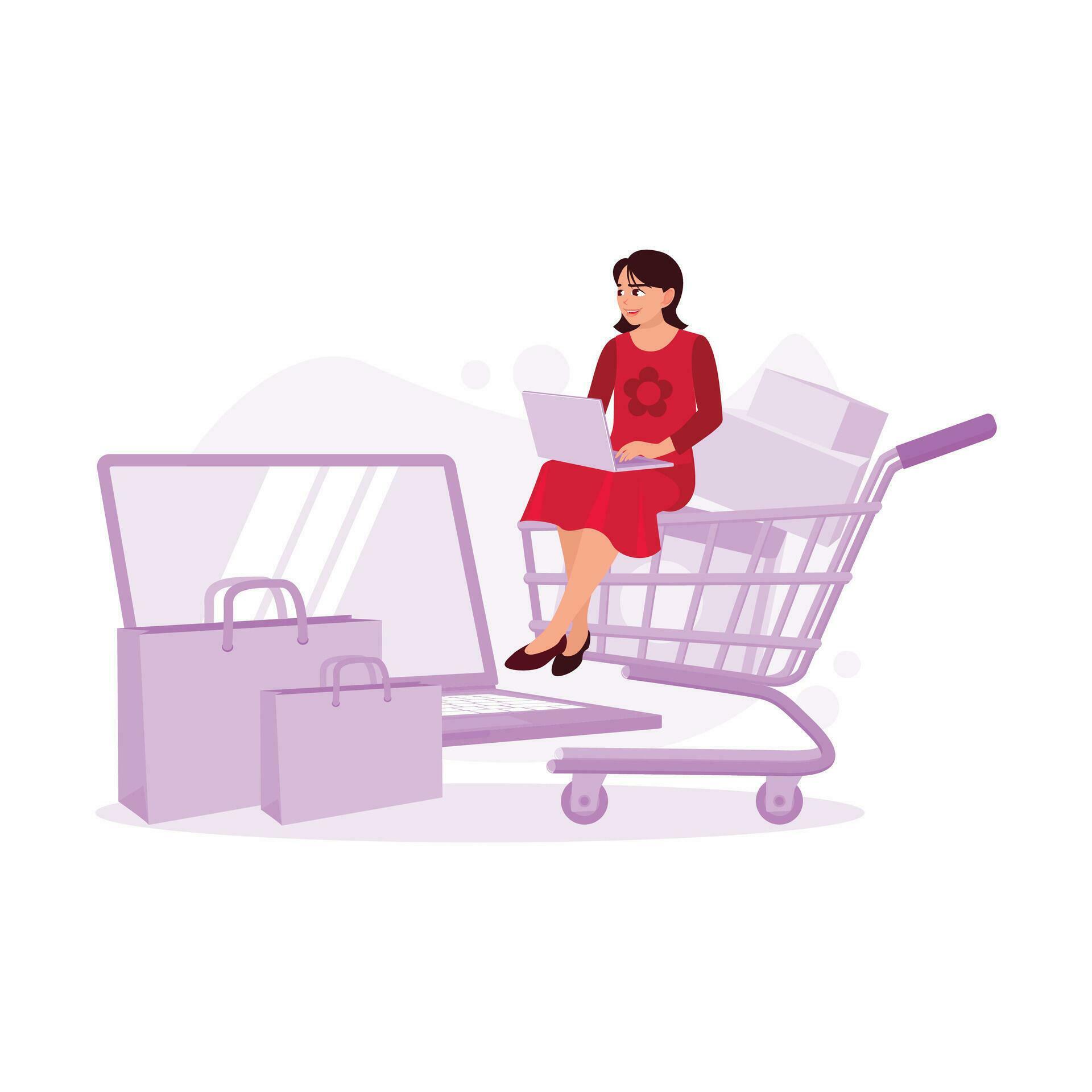 Portrait of a woman sitting on a trolley with a laptop and shopping bags. Online shopping ...