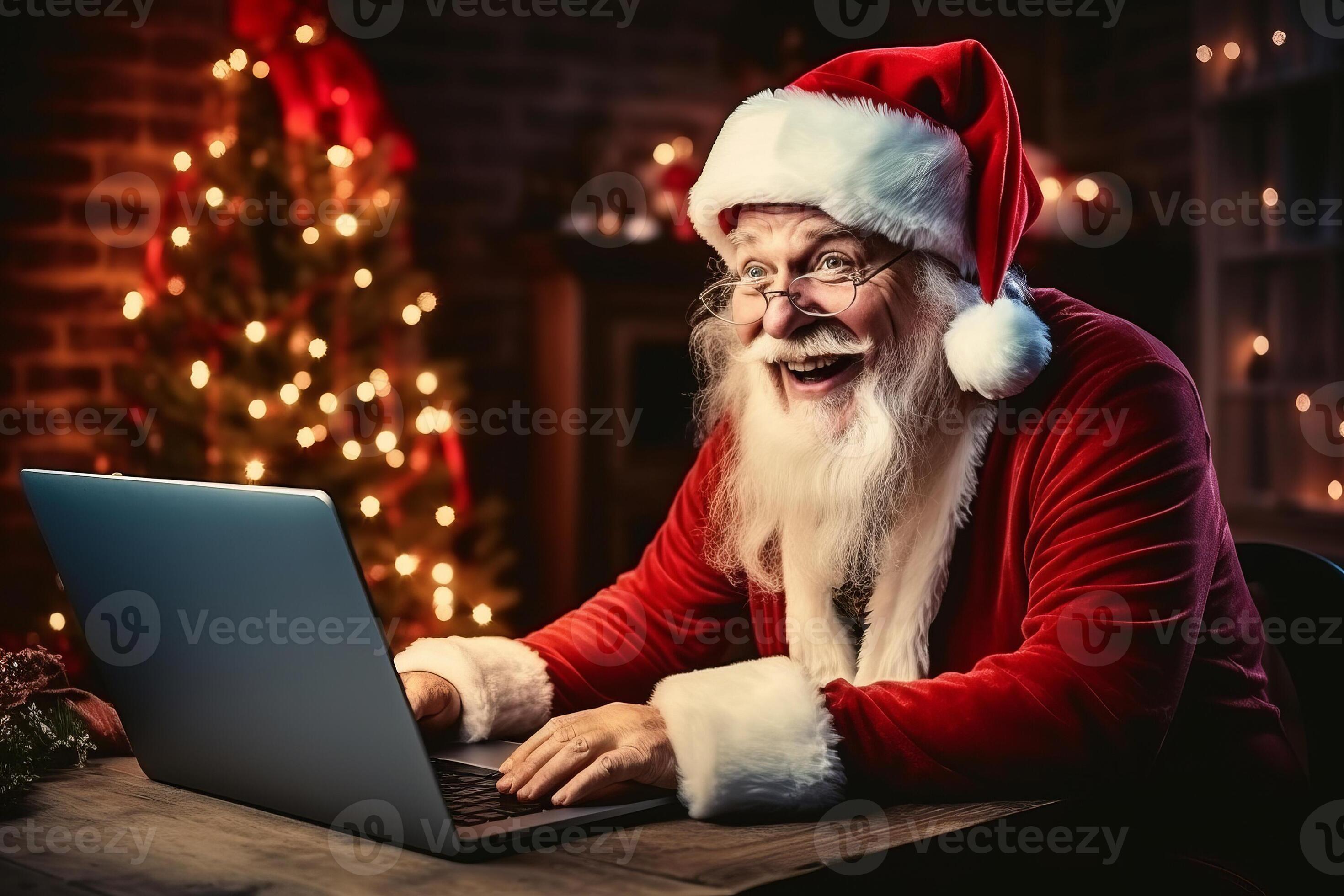 Happy old Santa Claus using laptop computer sitting at workshop home ...