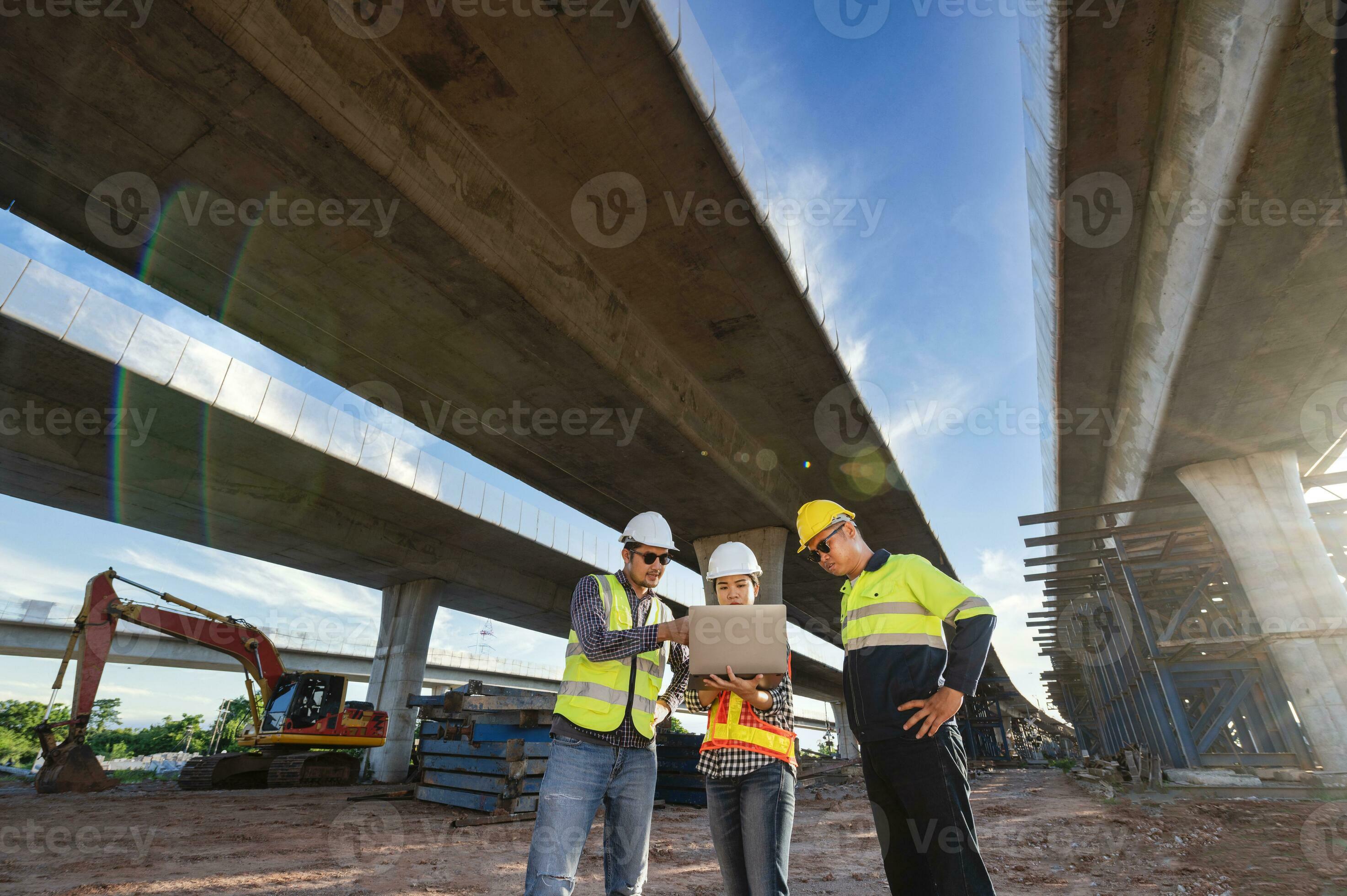Team of 3 Asian engineers inspecting expressway construction. Asian architect and mature ...