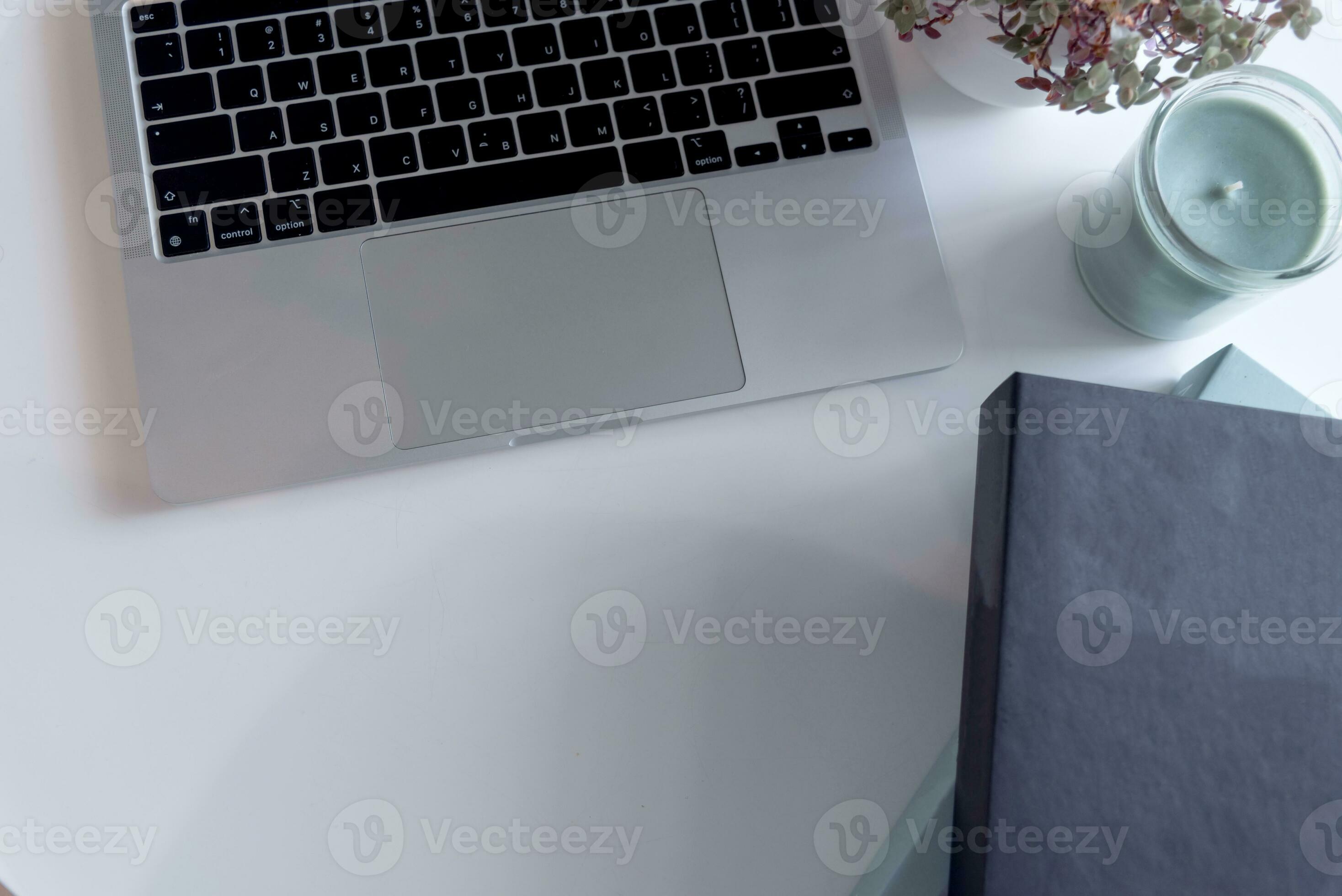 Top view laptop computer and book on white background. Flat lay with ...