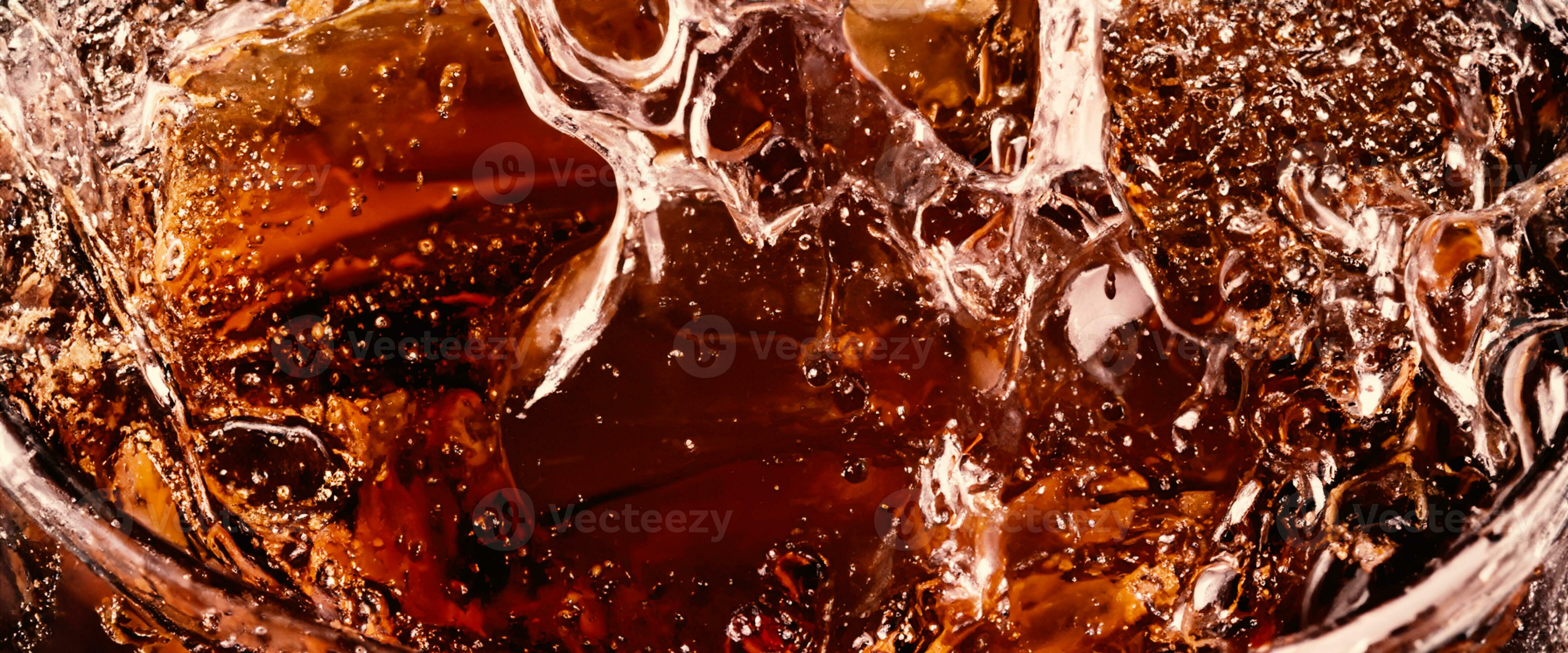 Splashing of Cola and Ice. Cola soda and ice splashing fizzing or floating up to top of surface ...