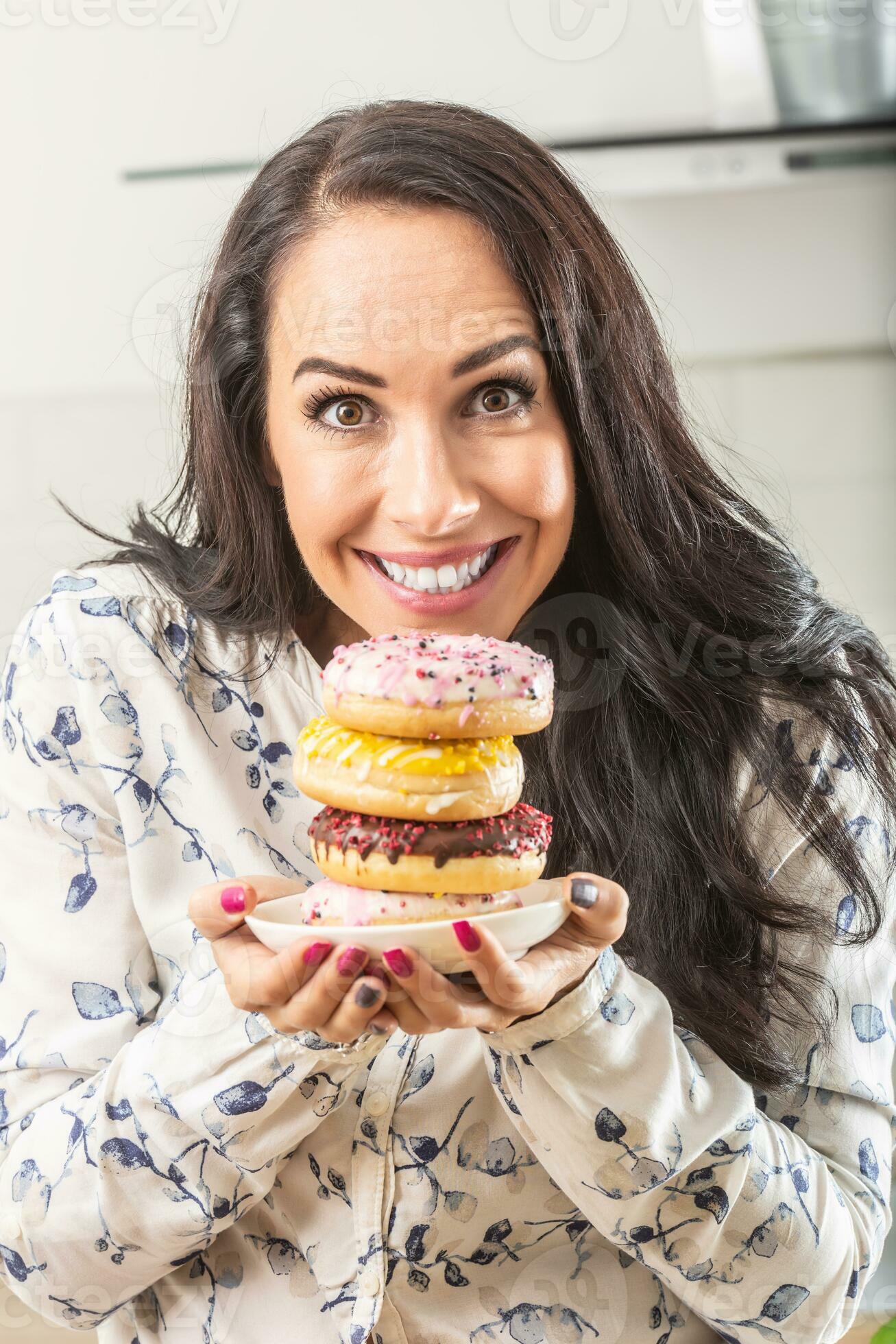Four Donuts On A Plate Held By A Good Looking Brunette Woman 27548863