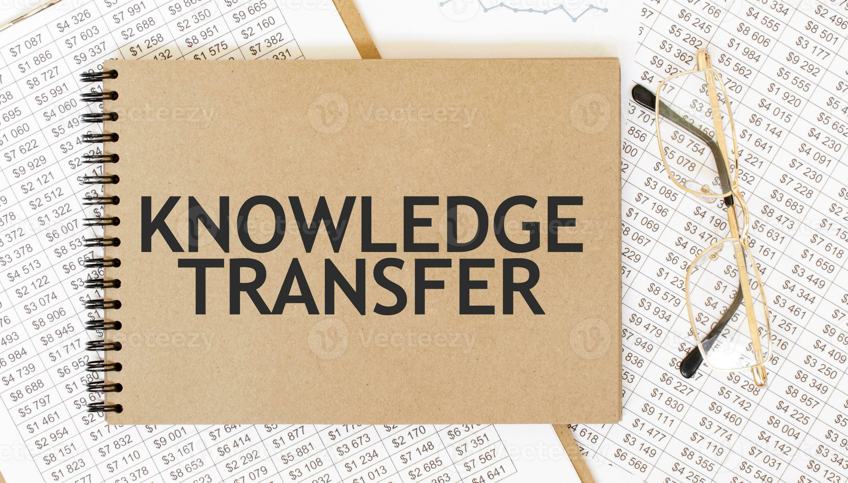 Craft colour notepad with text KNOWLEDGE TRANSFER. Notepad with eyeglasses and text documents ...